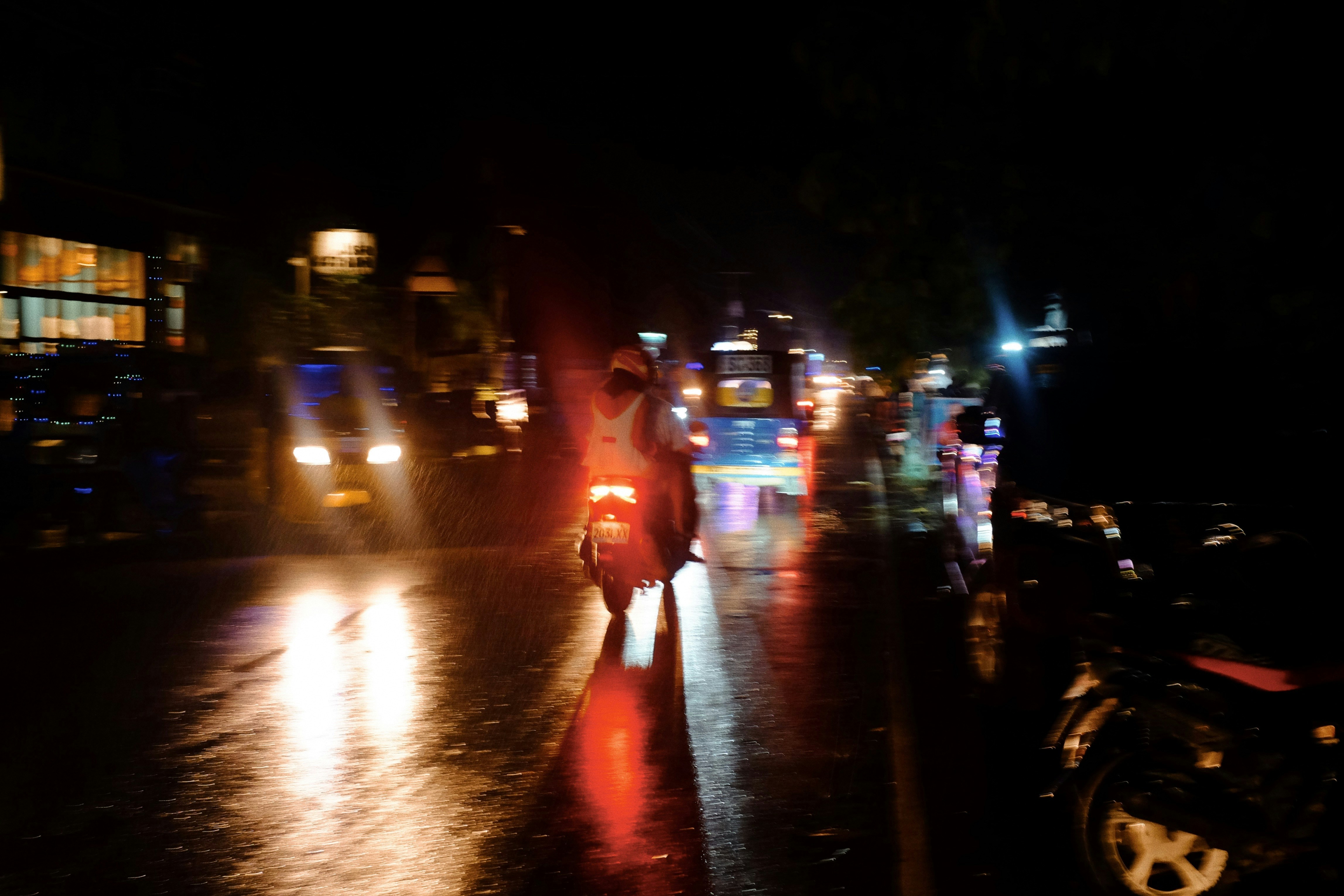 Nighttime traffic on a wet, reflective road. photo – Free Rain Image on ...