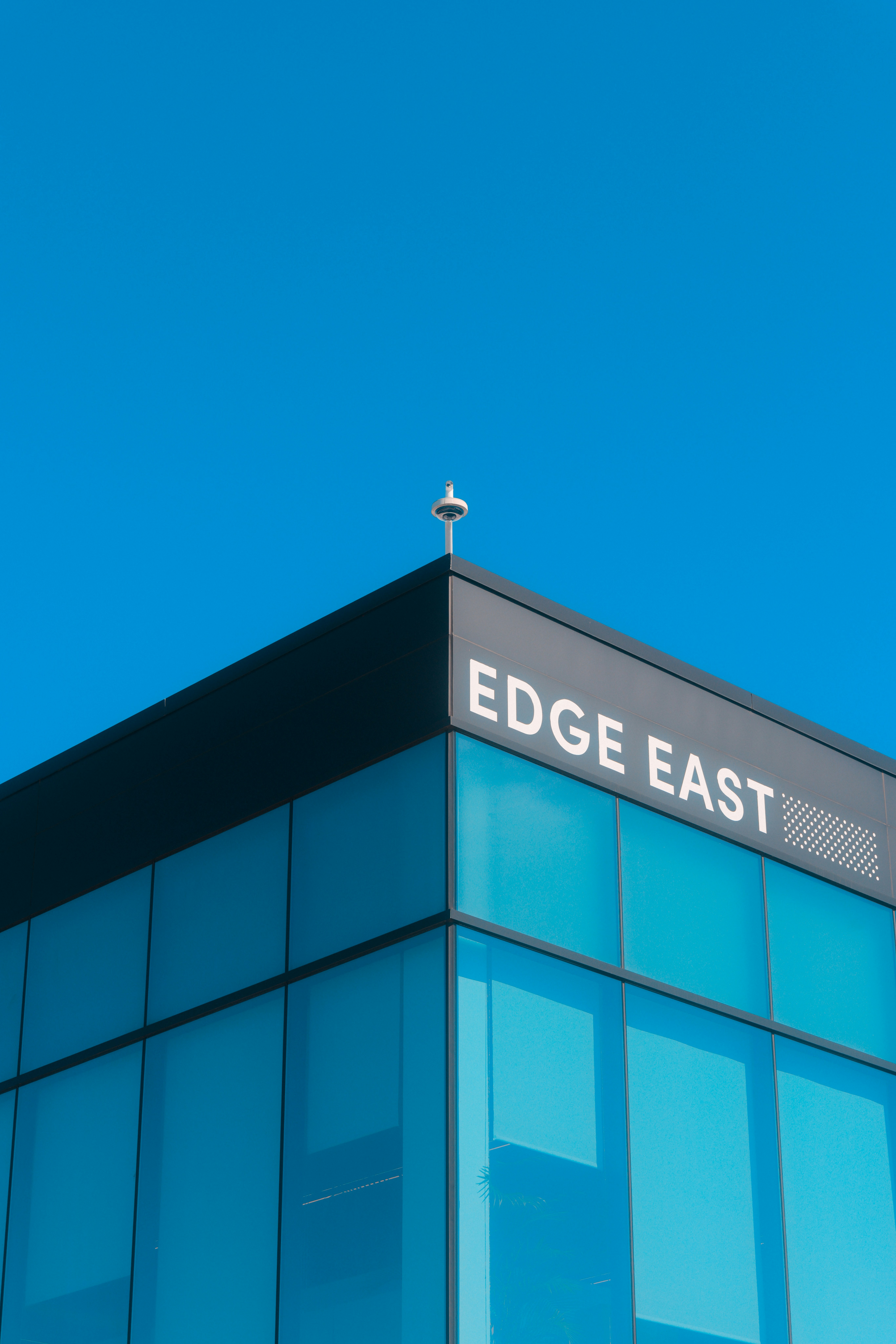 Modern building corner with "edge east" signage. photo – Free City ...