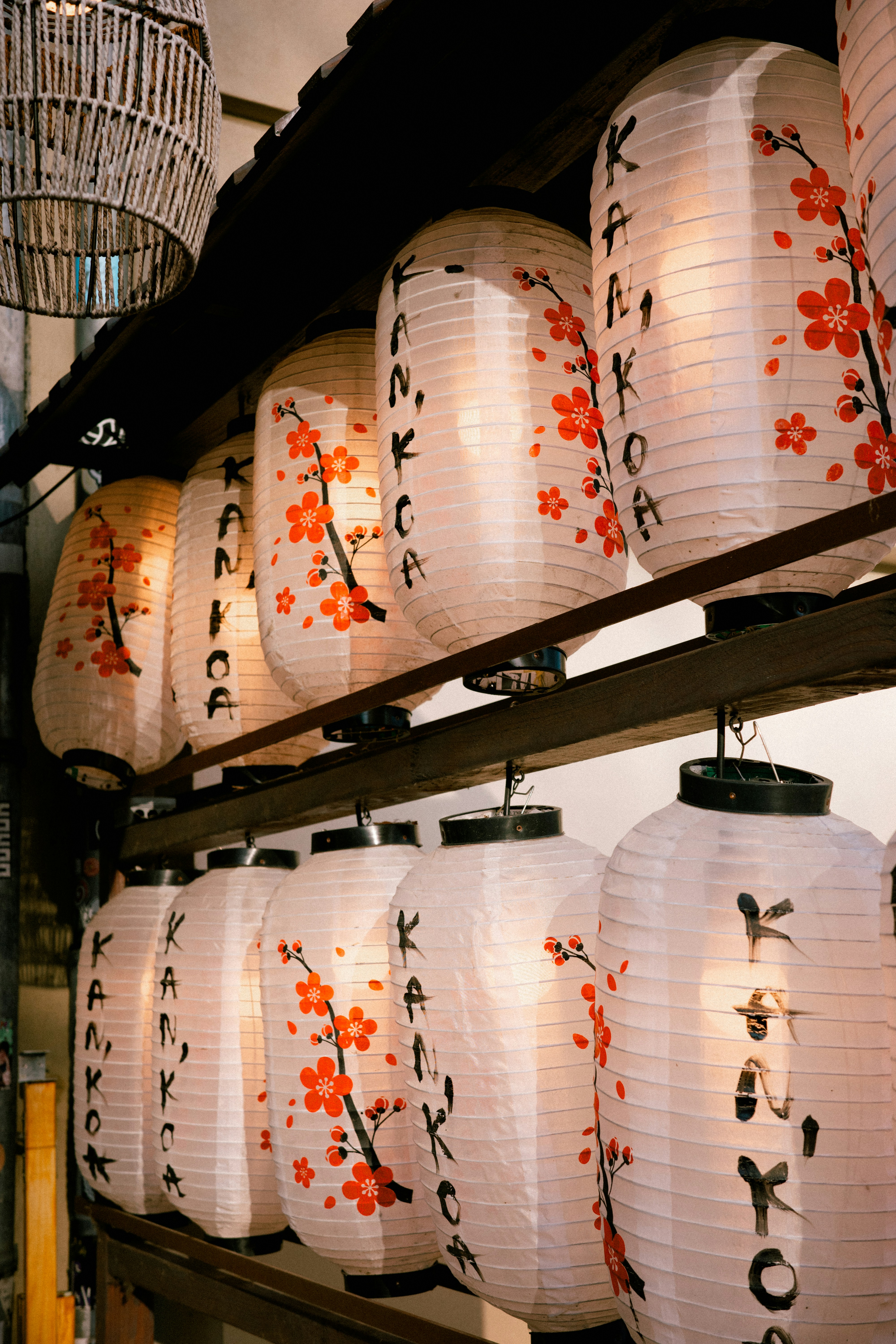 Lantern Row: Blossoms and Soft Light in a Market Corridor
