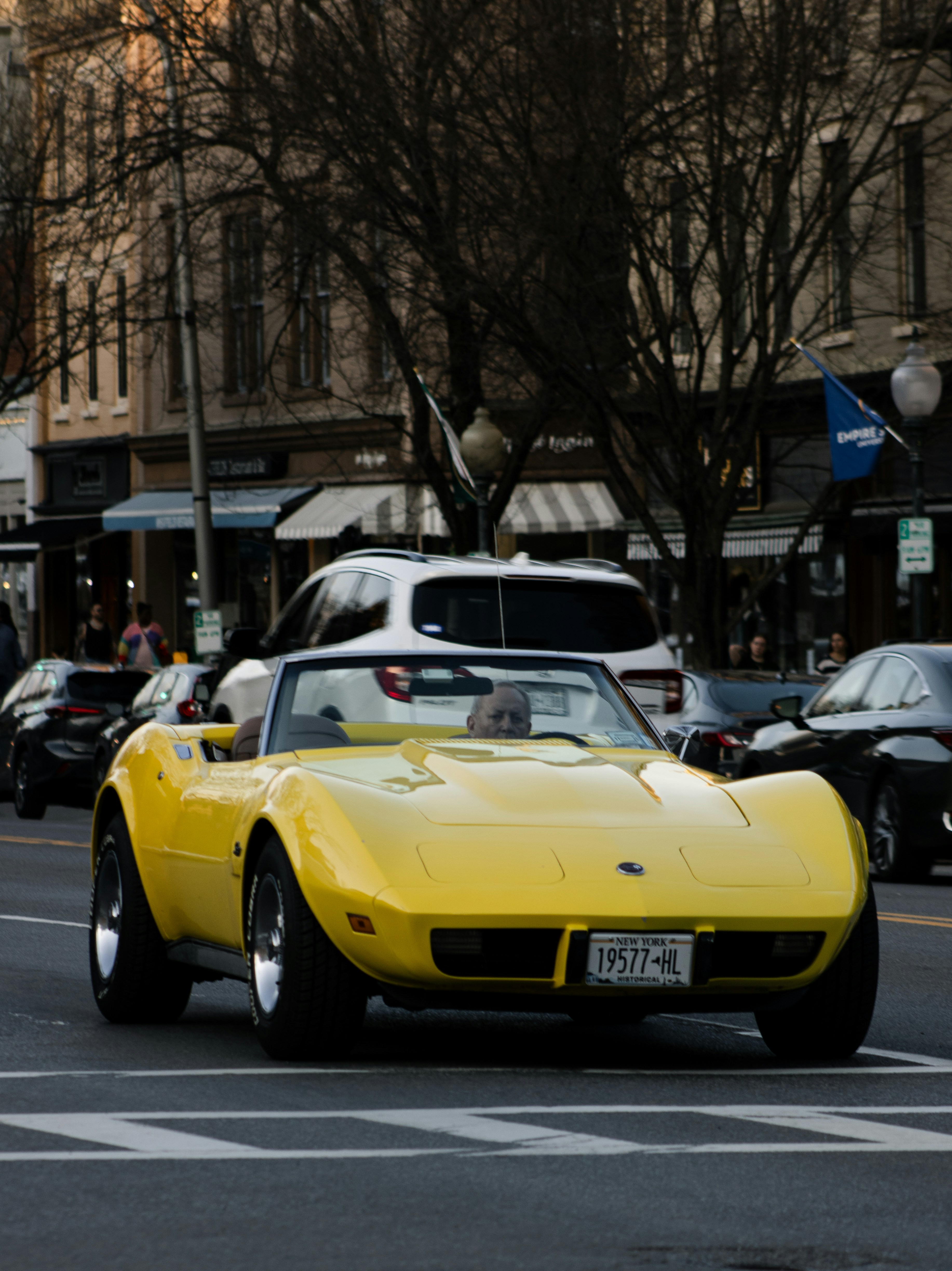 Urban Pulse in Yellow: A Convertible Car on a City Drive