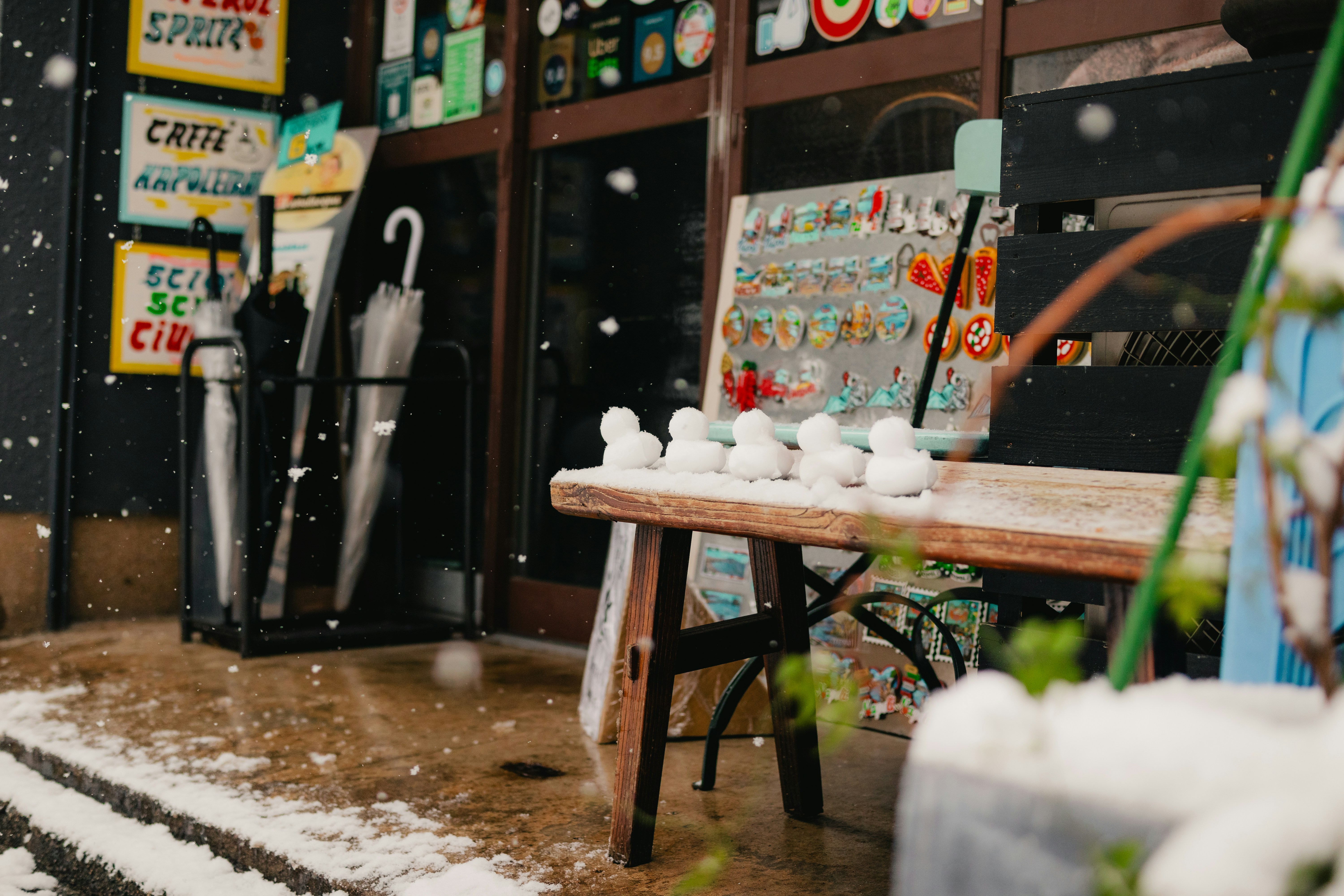 Snowfall on a Shopfront Bench: White Mounds in Winter Glow