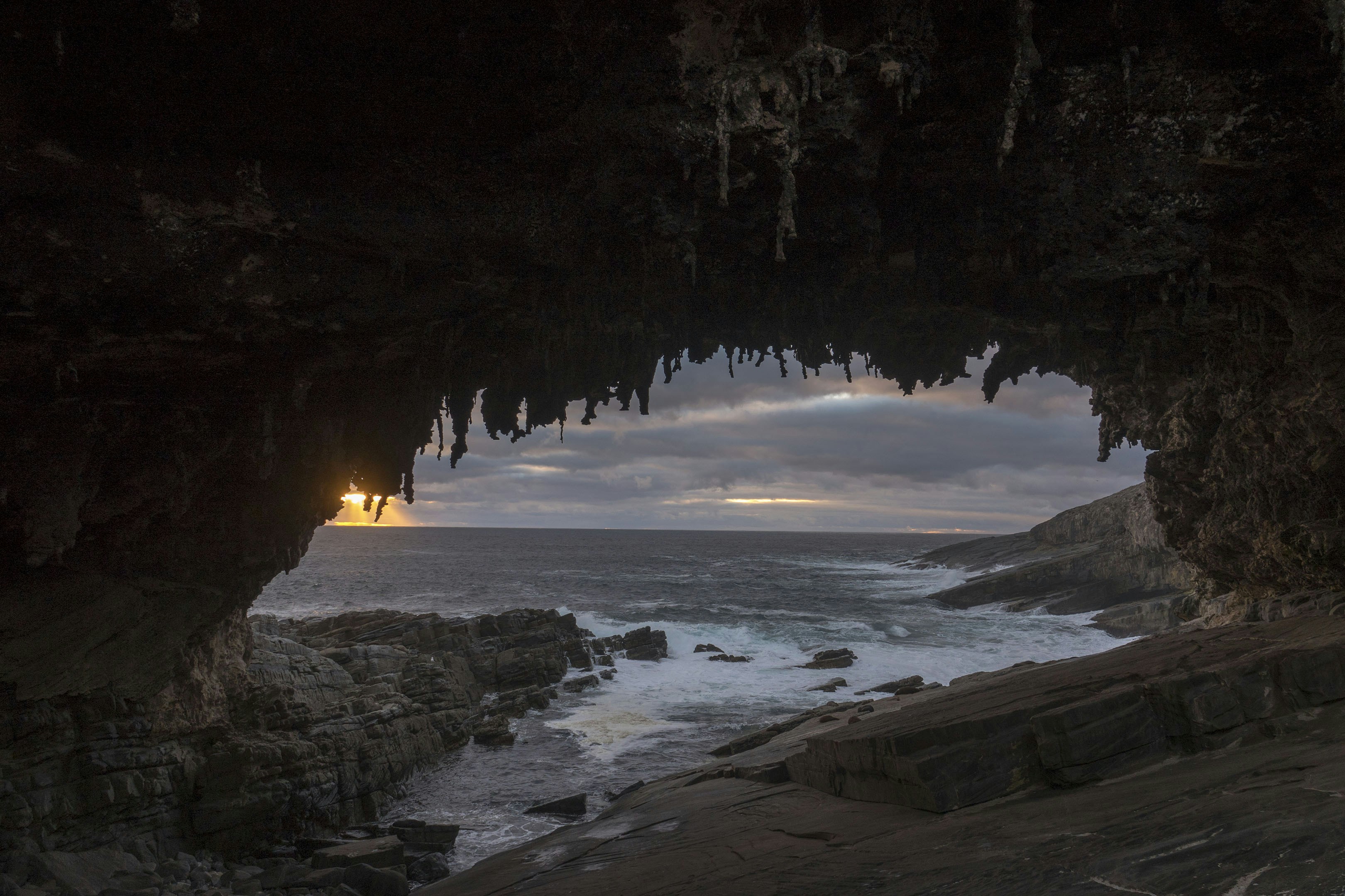 Cave opening frames a beautiful ocean sunset. photo – Free Beach Image ...