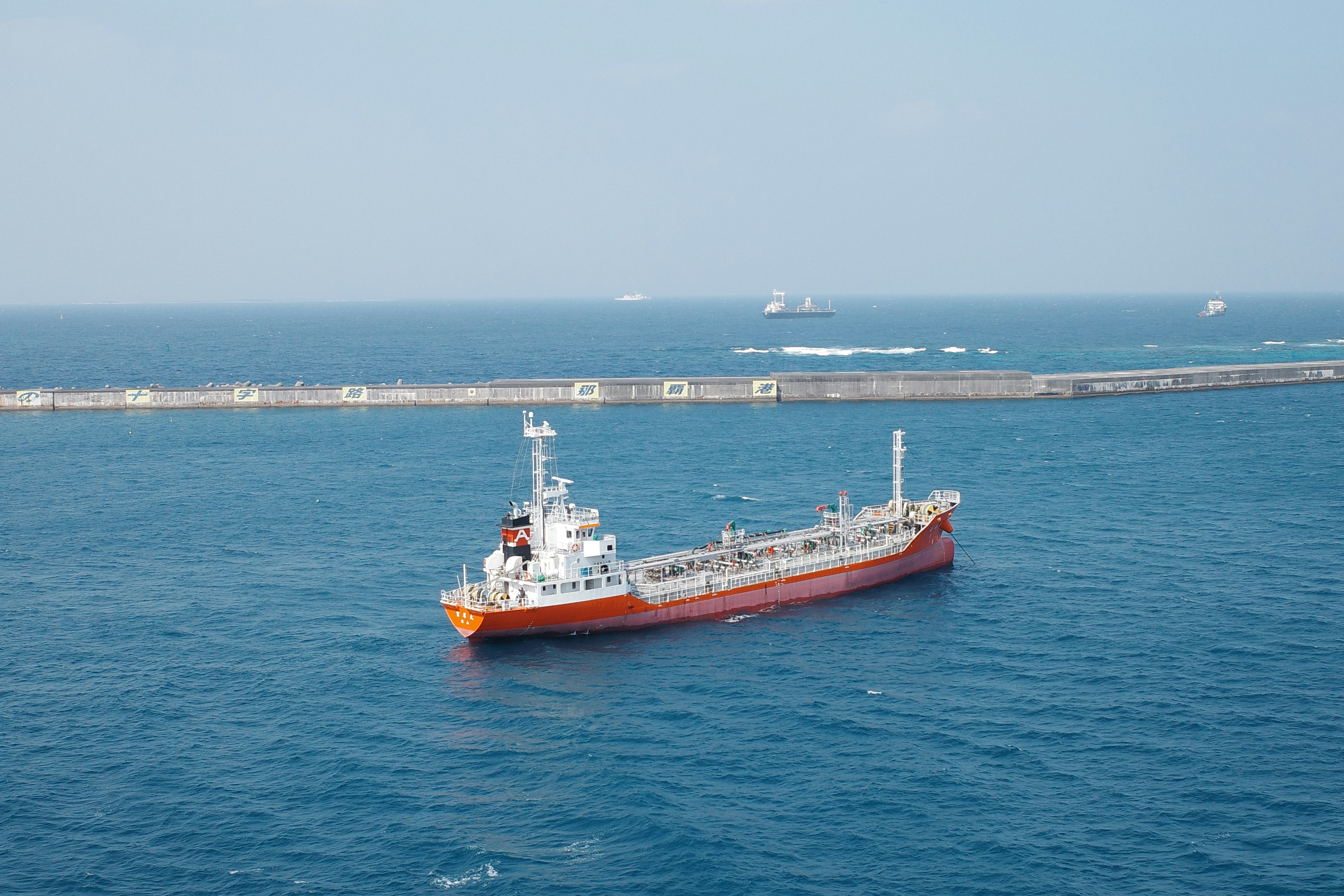 A red ship sails on the calm, blue ocean. photo – Free Sea Image on ...