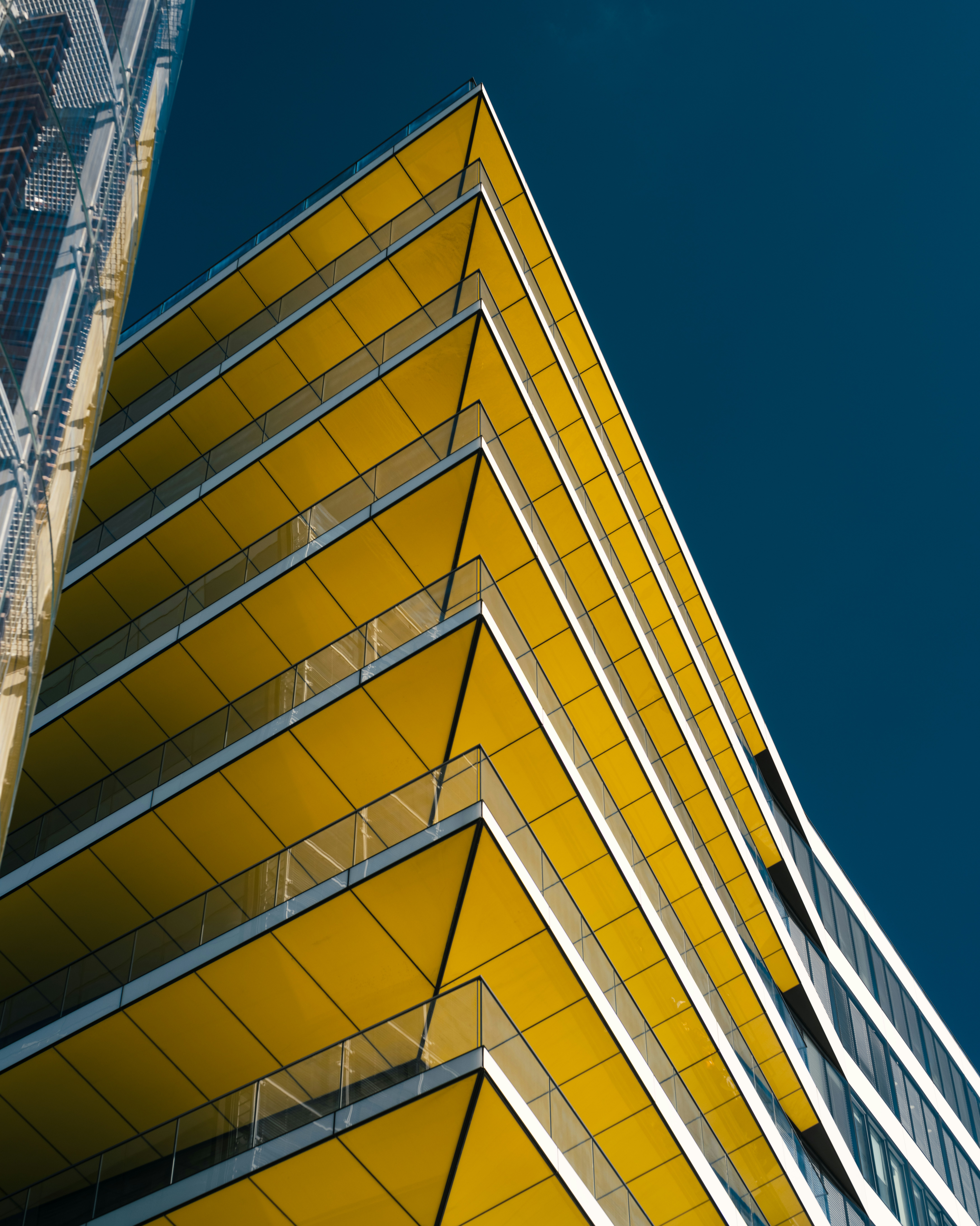 Yellow balconies on a modern, angular building. photo – Free Building ...