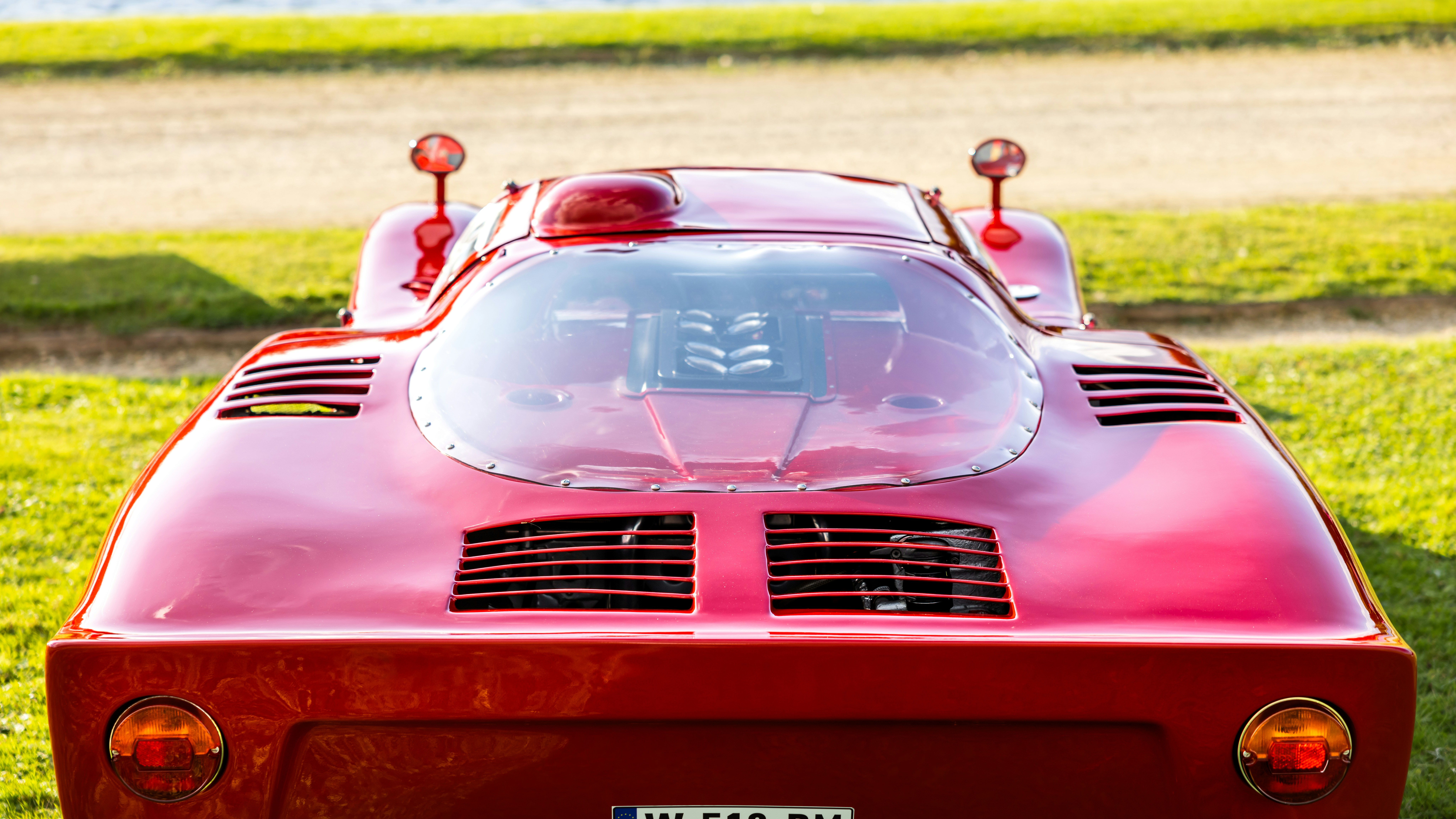 A retro red car is displayed outdoors. photo – Free Lamborghini Image ...