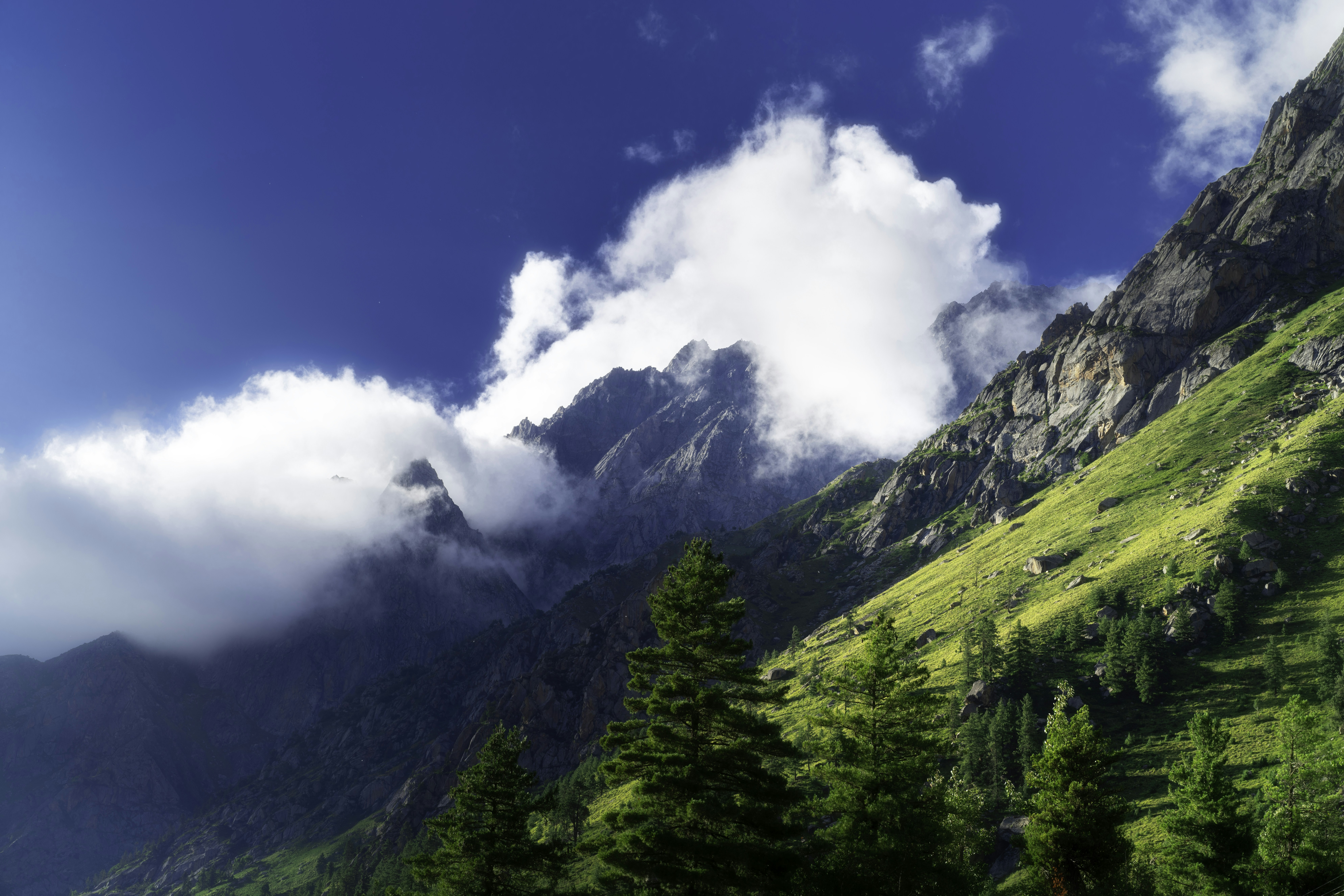 Mountains and clouds stand under a bright blue sky. photo – Free Travel ...