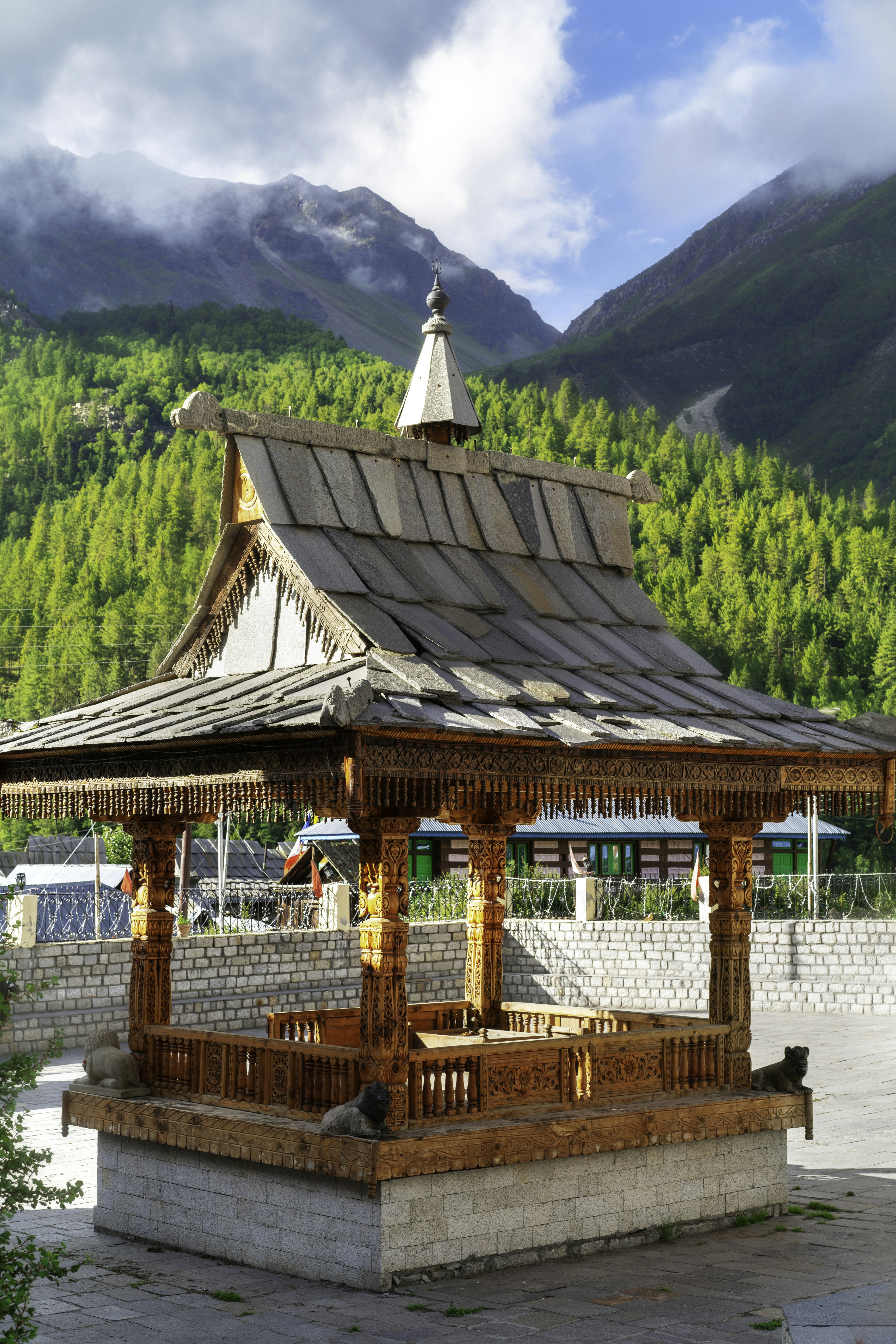 The Carved Timber Pavilion Beneath Emerald Peaks