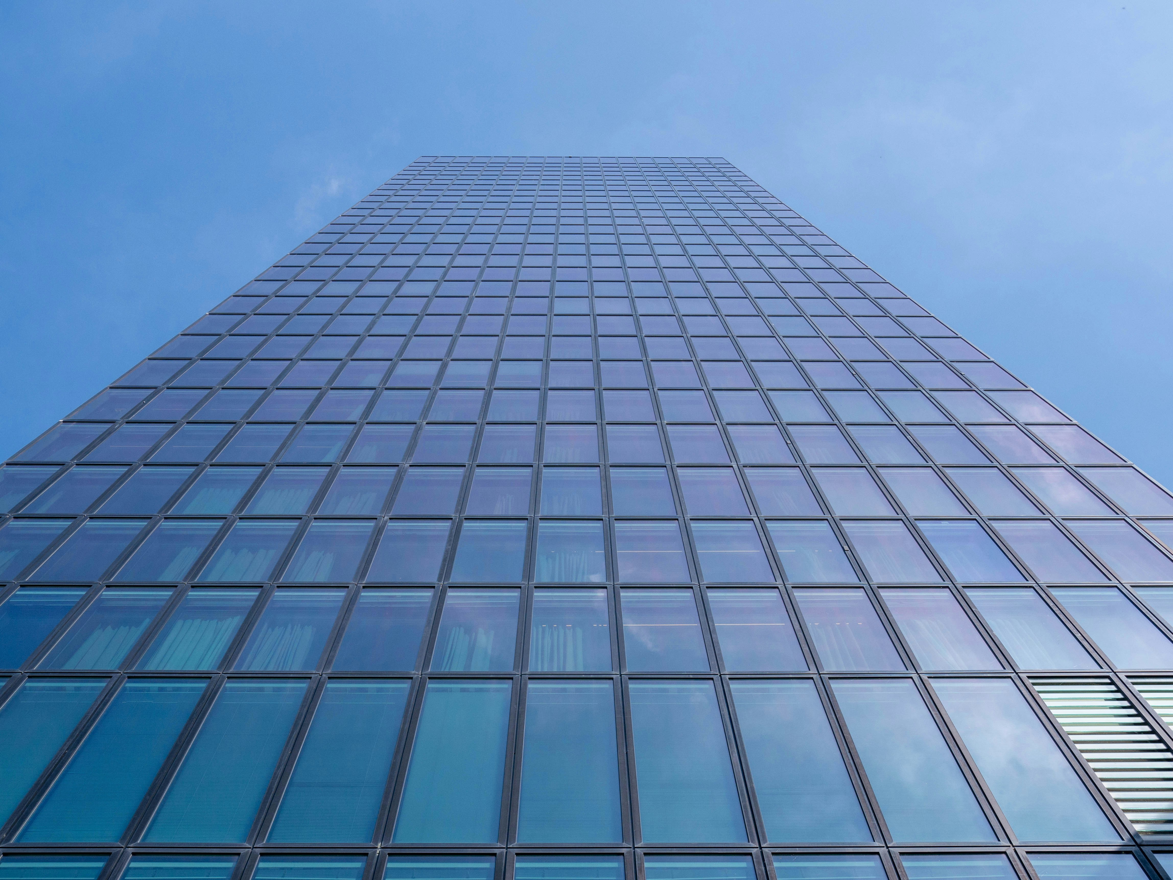 Skyscraper facade reflecting the blue sky with geometric precision.