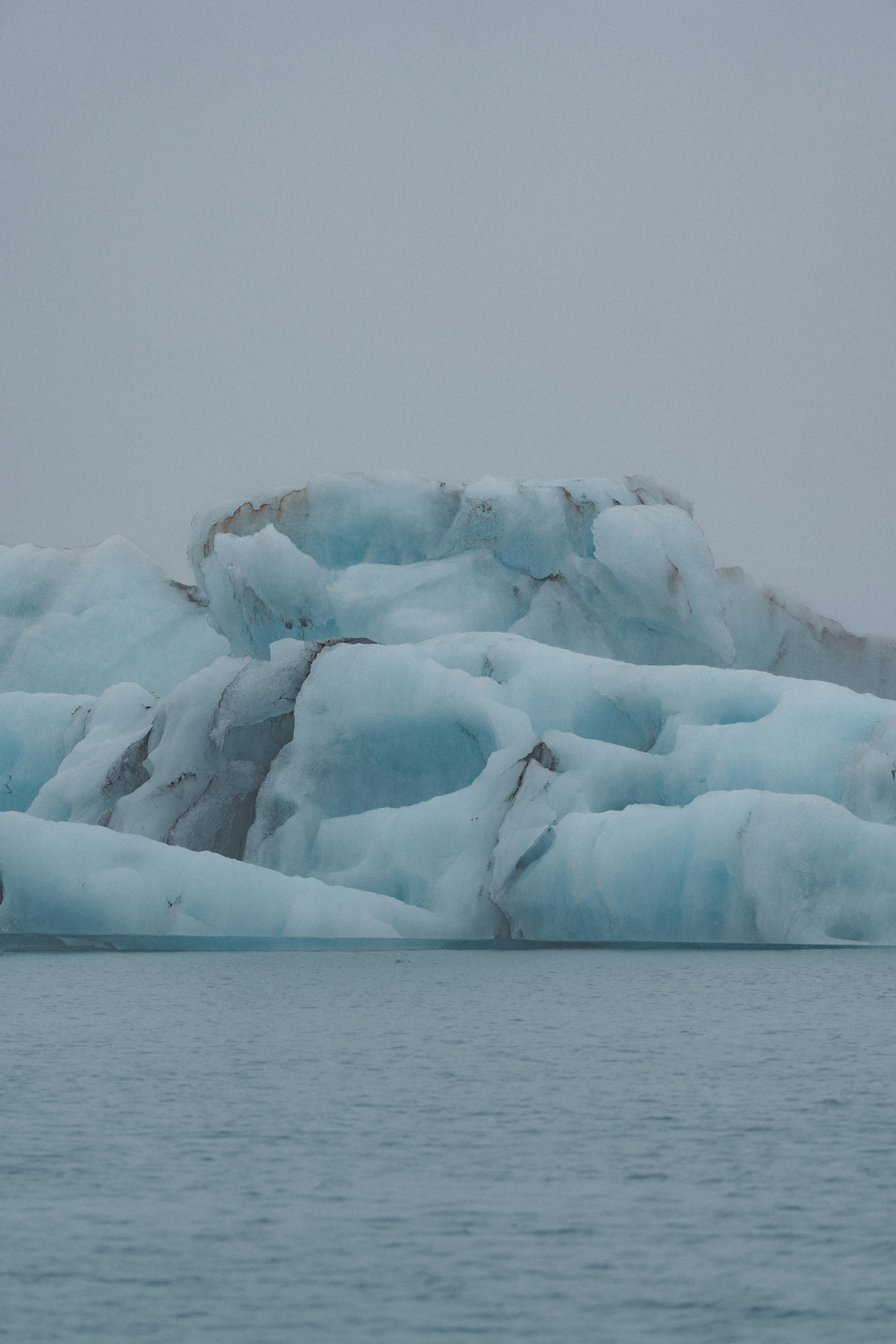 Icebergs float in the cold, blue ocean. photo – Free Beach Image on ...