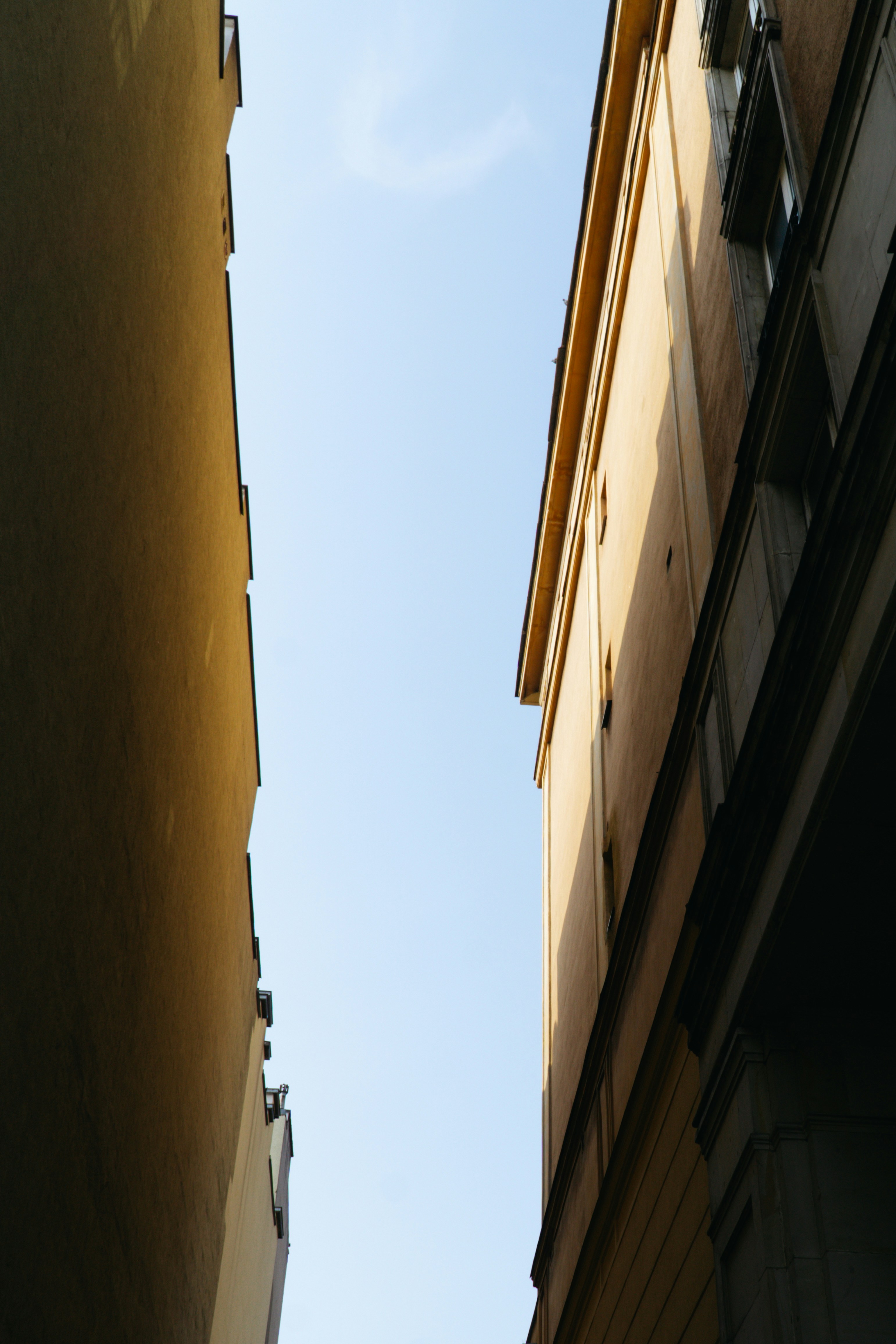 Buildings flank a clear sky in this view. photo – Free Building Image ...