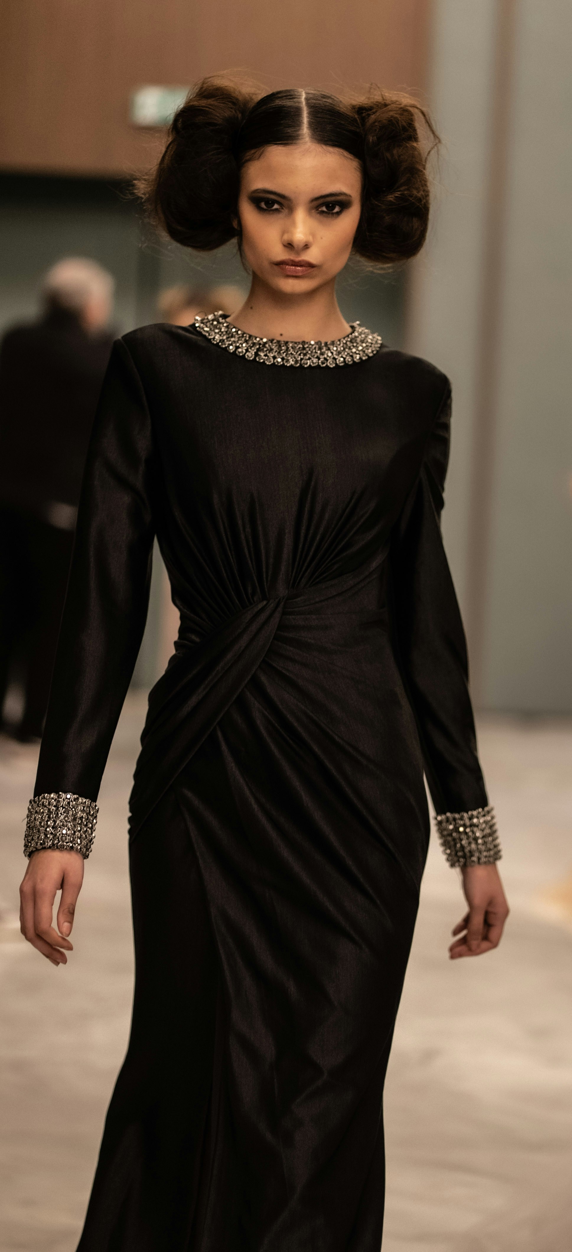 Model walks a runway in a black embellished dress. photo – Free Woman ...