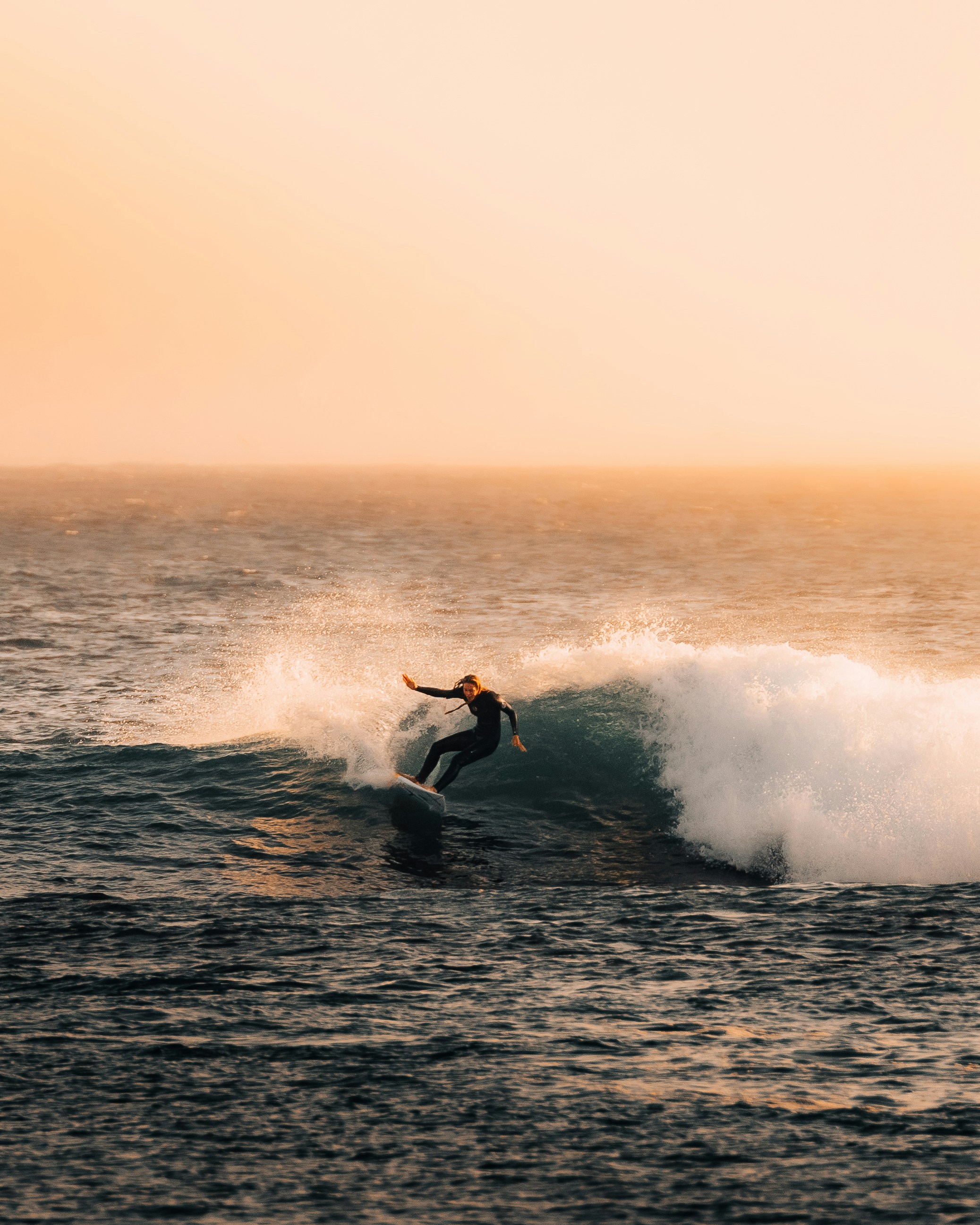 Surfer catching a wave during a beautiful sunset. photo – Free Sea ...