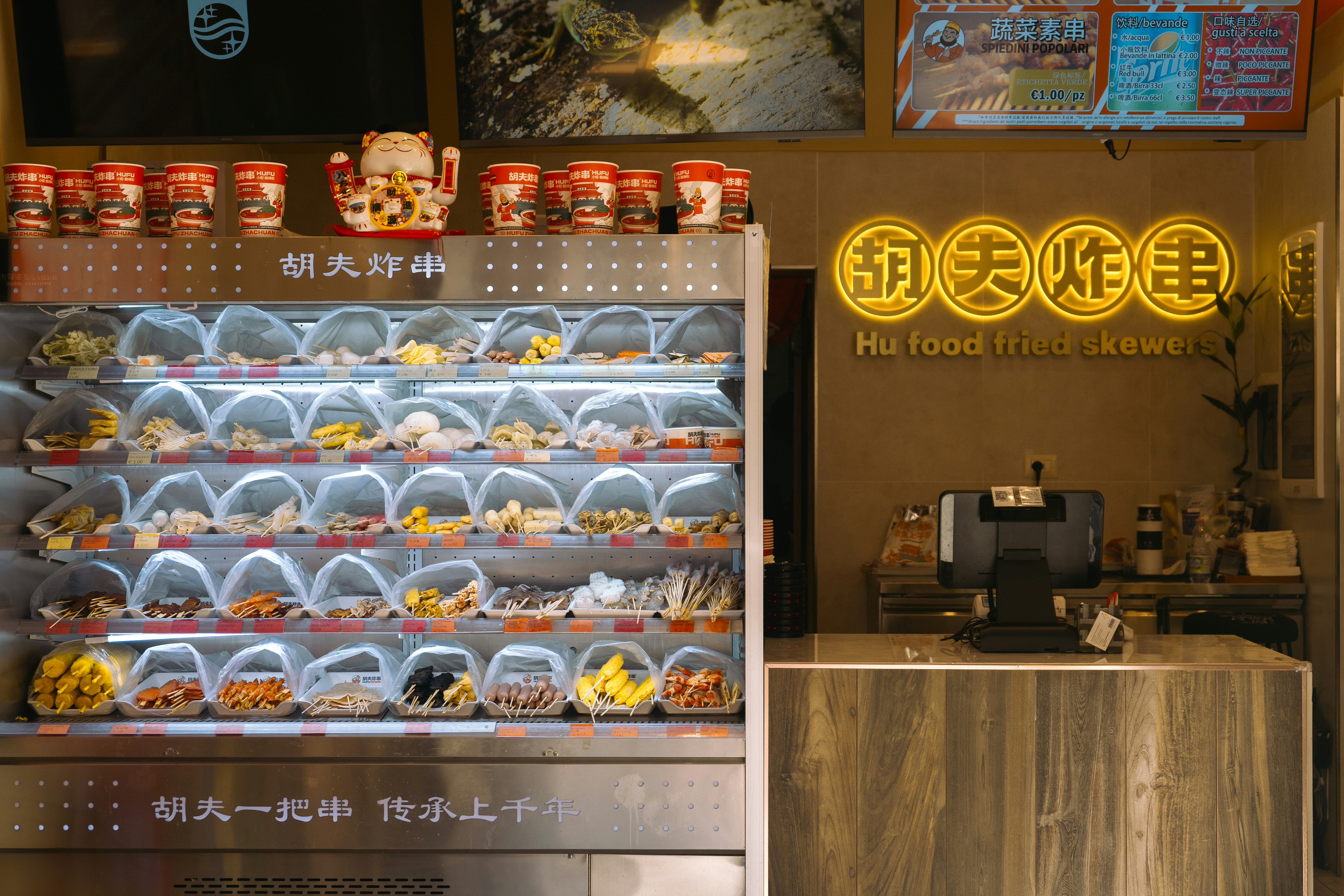 Variety of skewers displayed in a well-lit case at a Chinese restaurant.