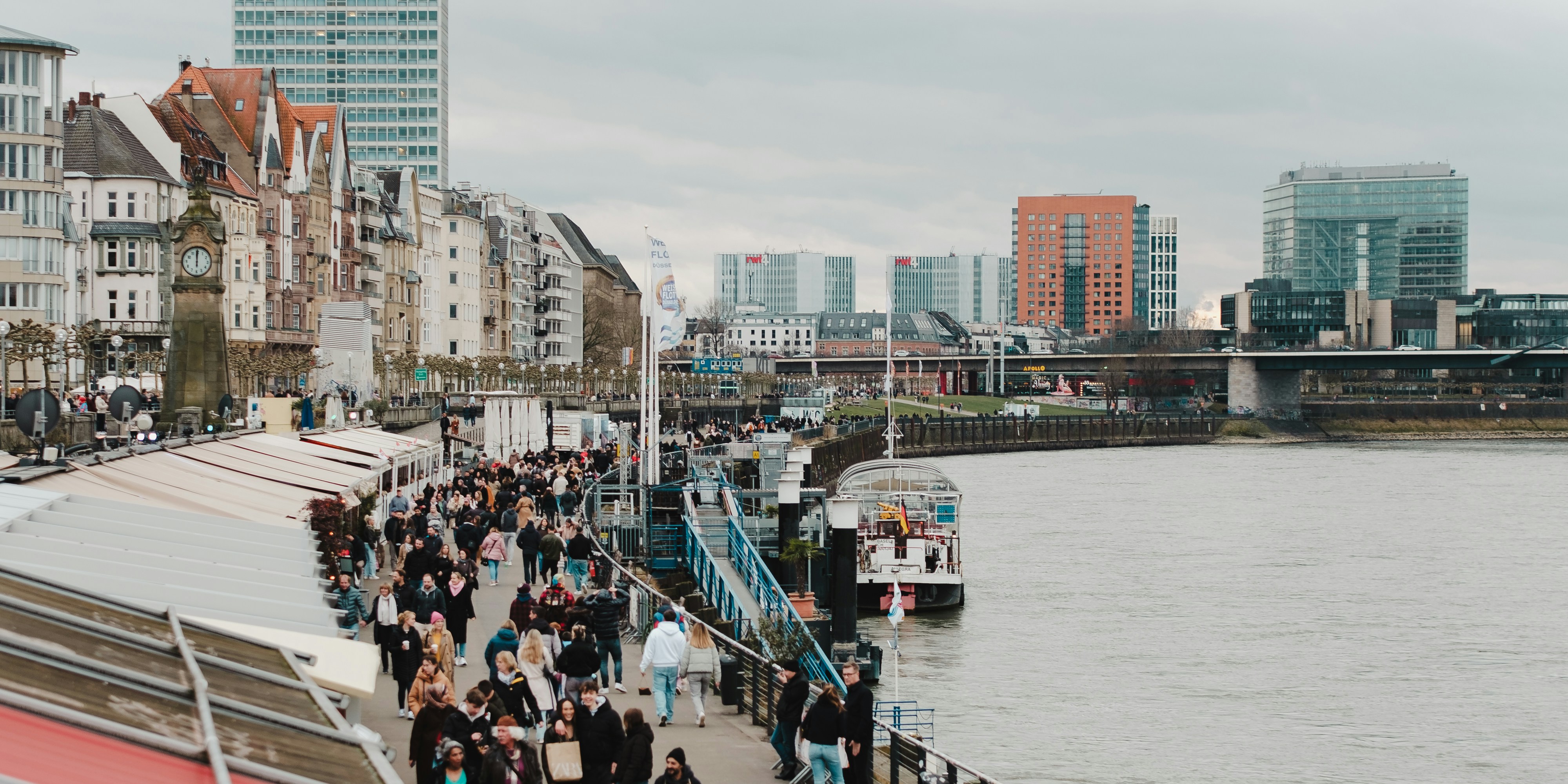 People walk along the river in a european city. photo – Free City Image ...