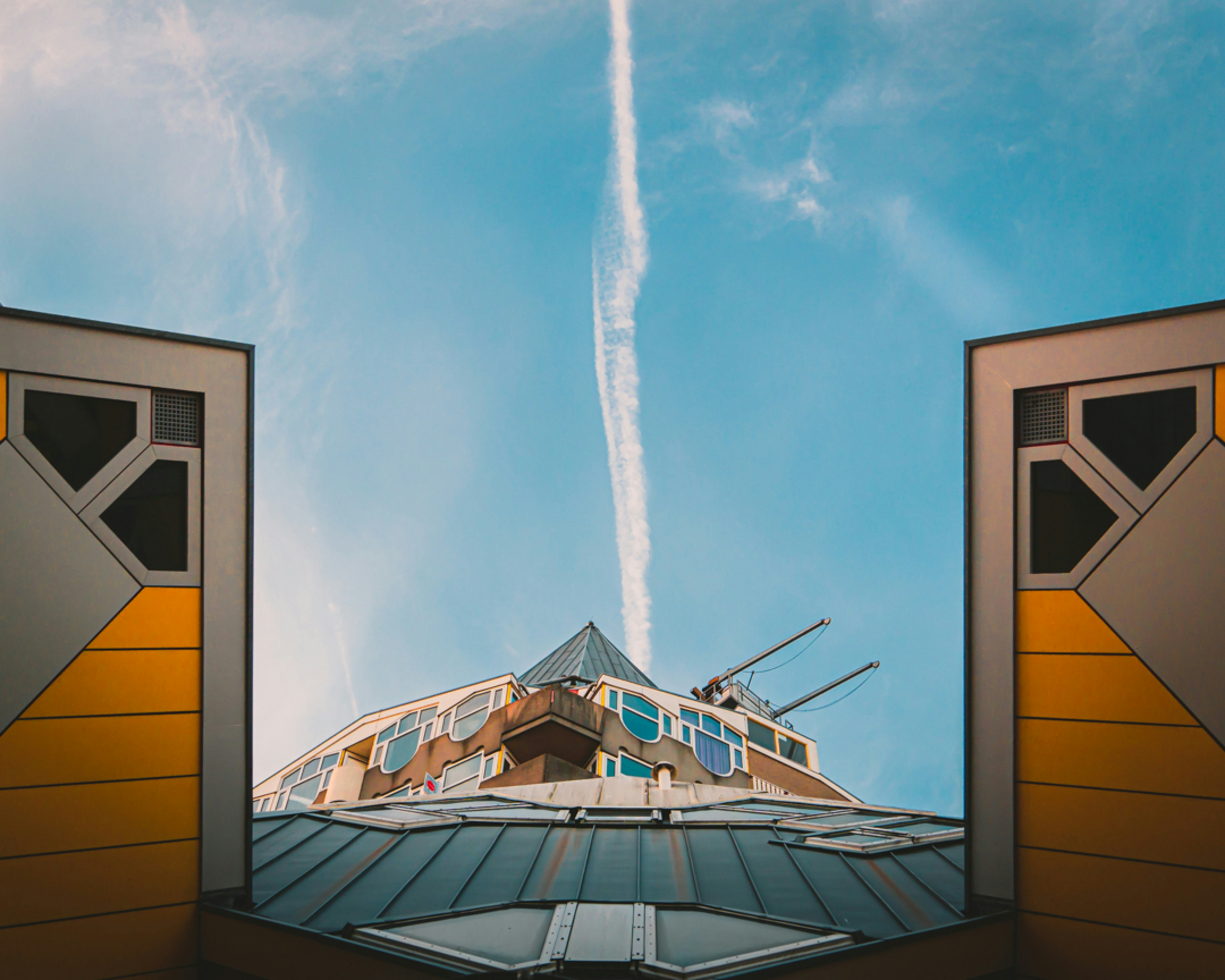Amber Towers Framing a Glass Atrium Beneath a Luminous Contrail