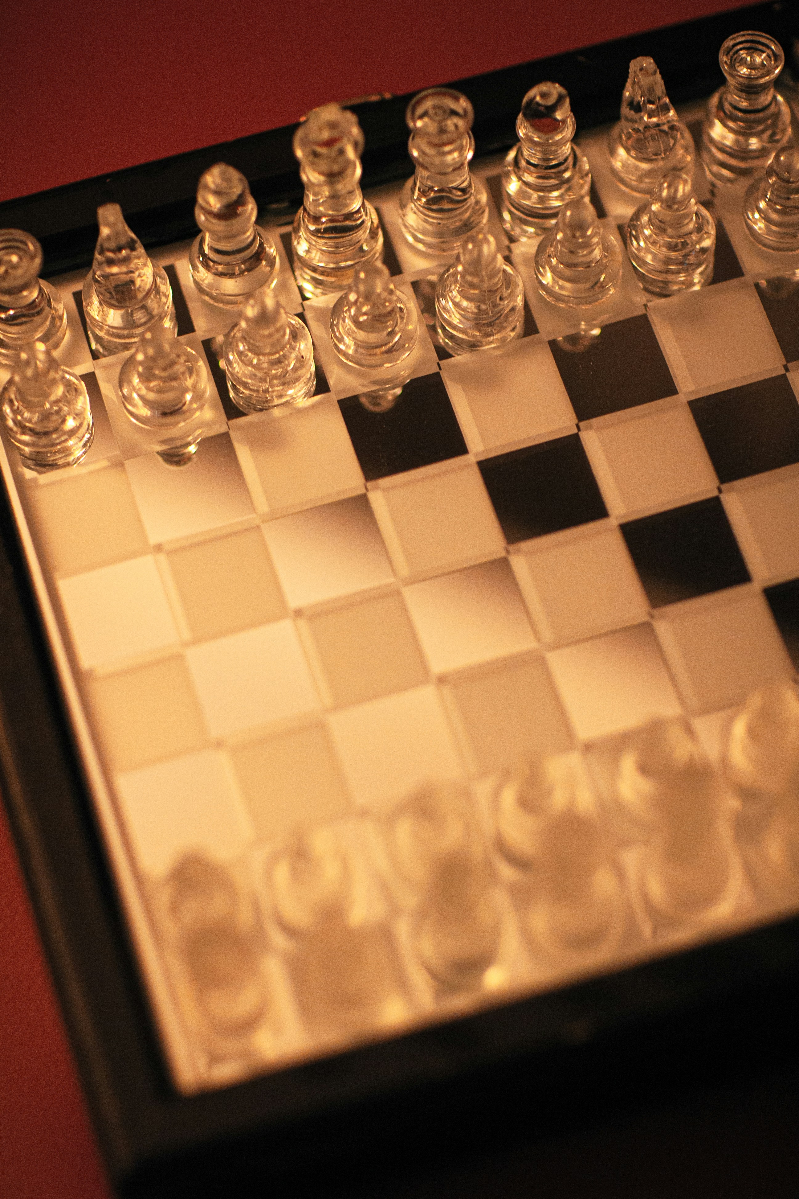 Amber Light Traces a Row of Glass Chessmen