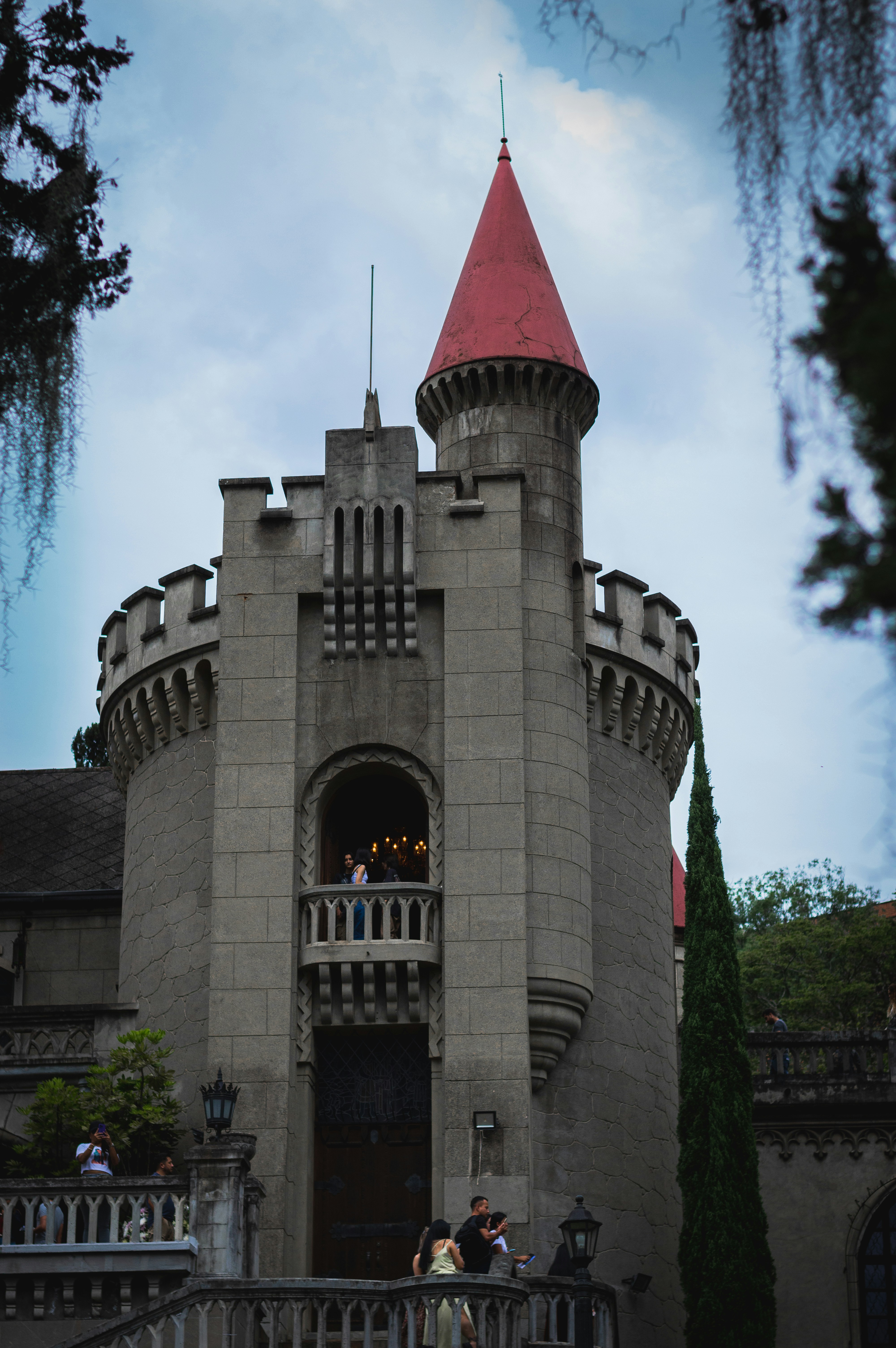 Crimson Spire Overlook: A Stone Keep Framed by Balcony Visitors