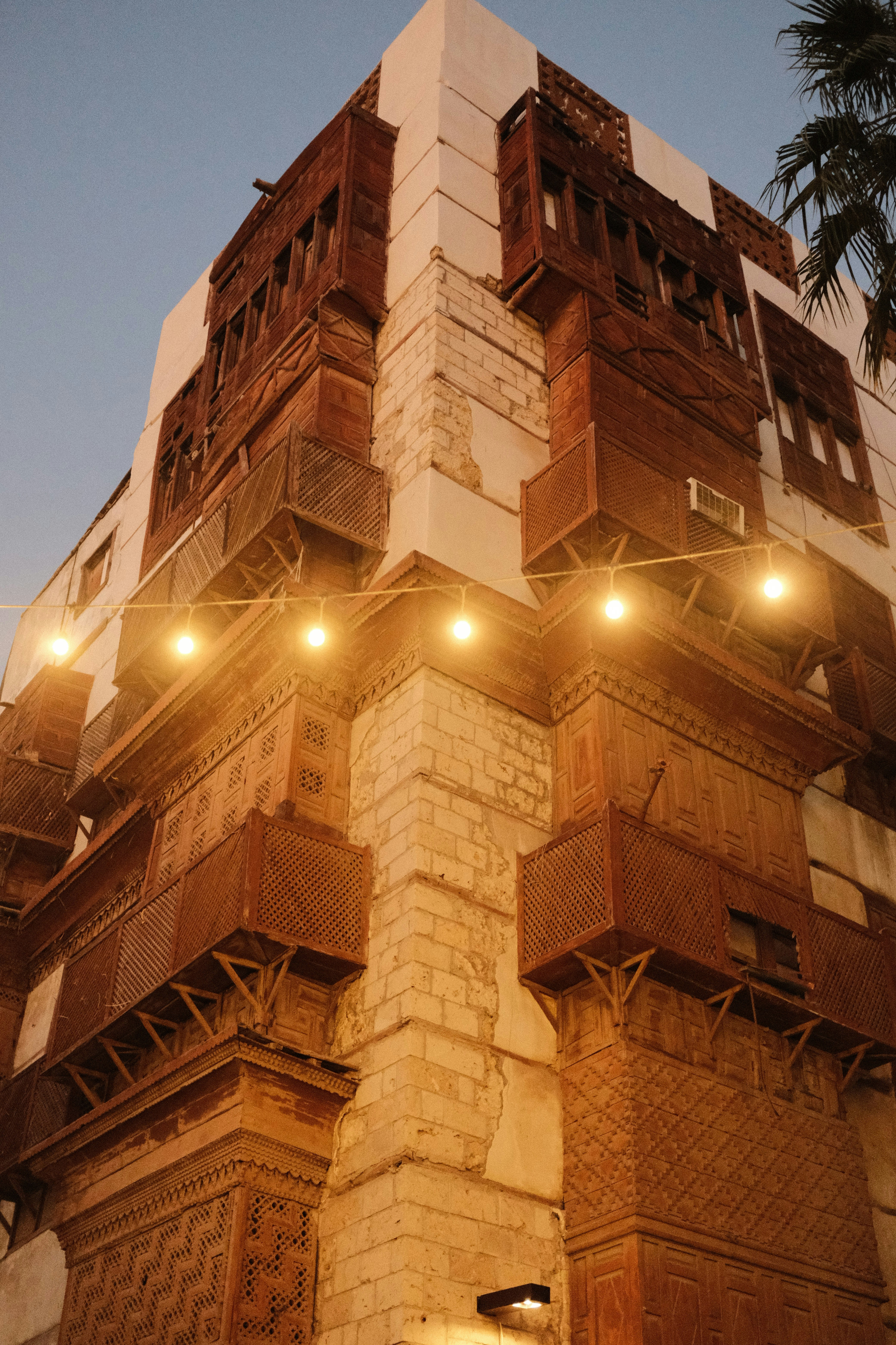 Lantern-Lit Facade: A Tower of Timbered Balconies