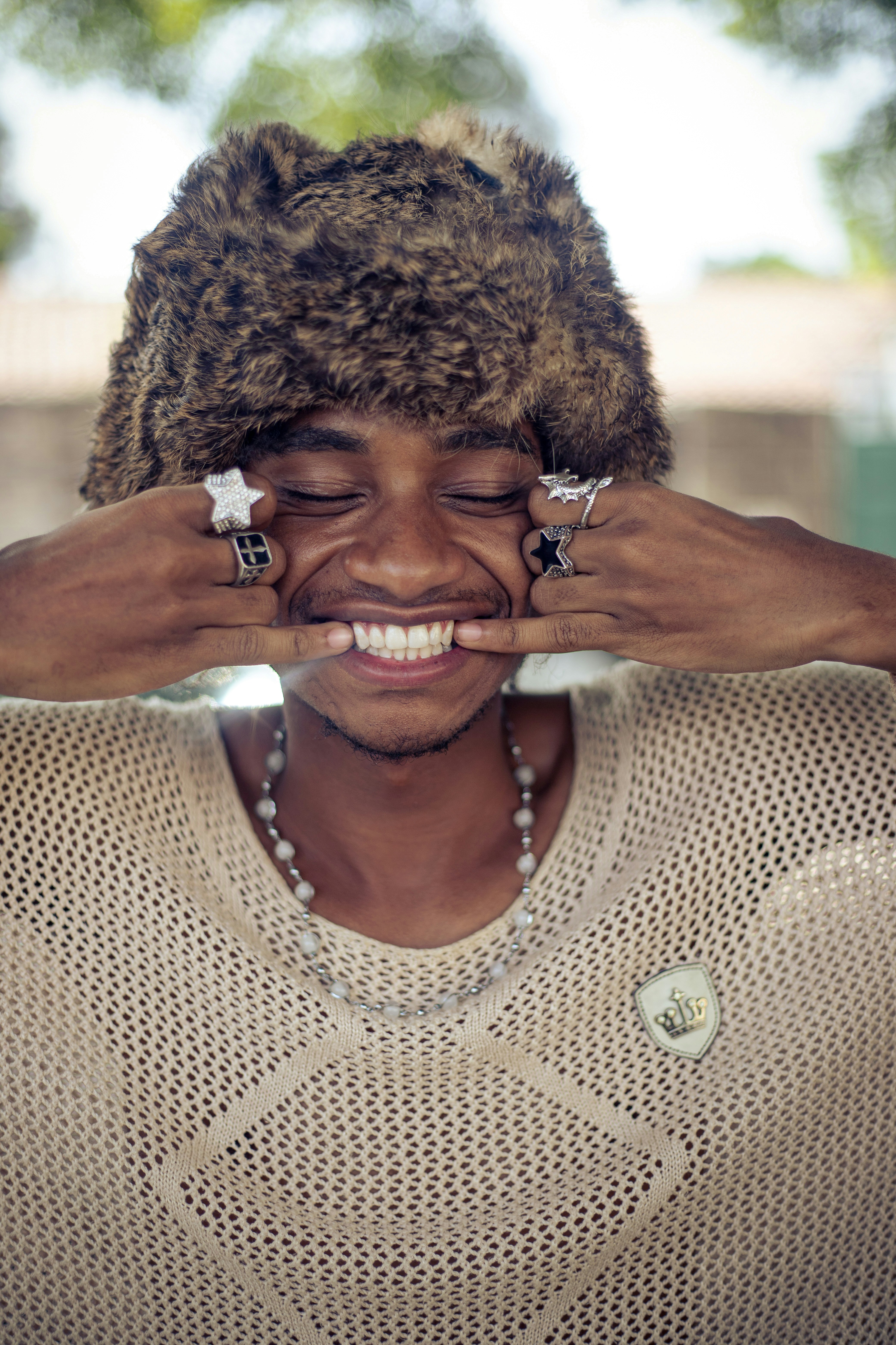 Broad Smile, Knit Crown: A Portrait of Joy in Knitwear