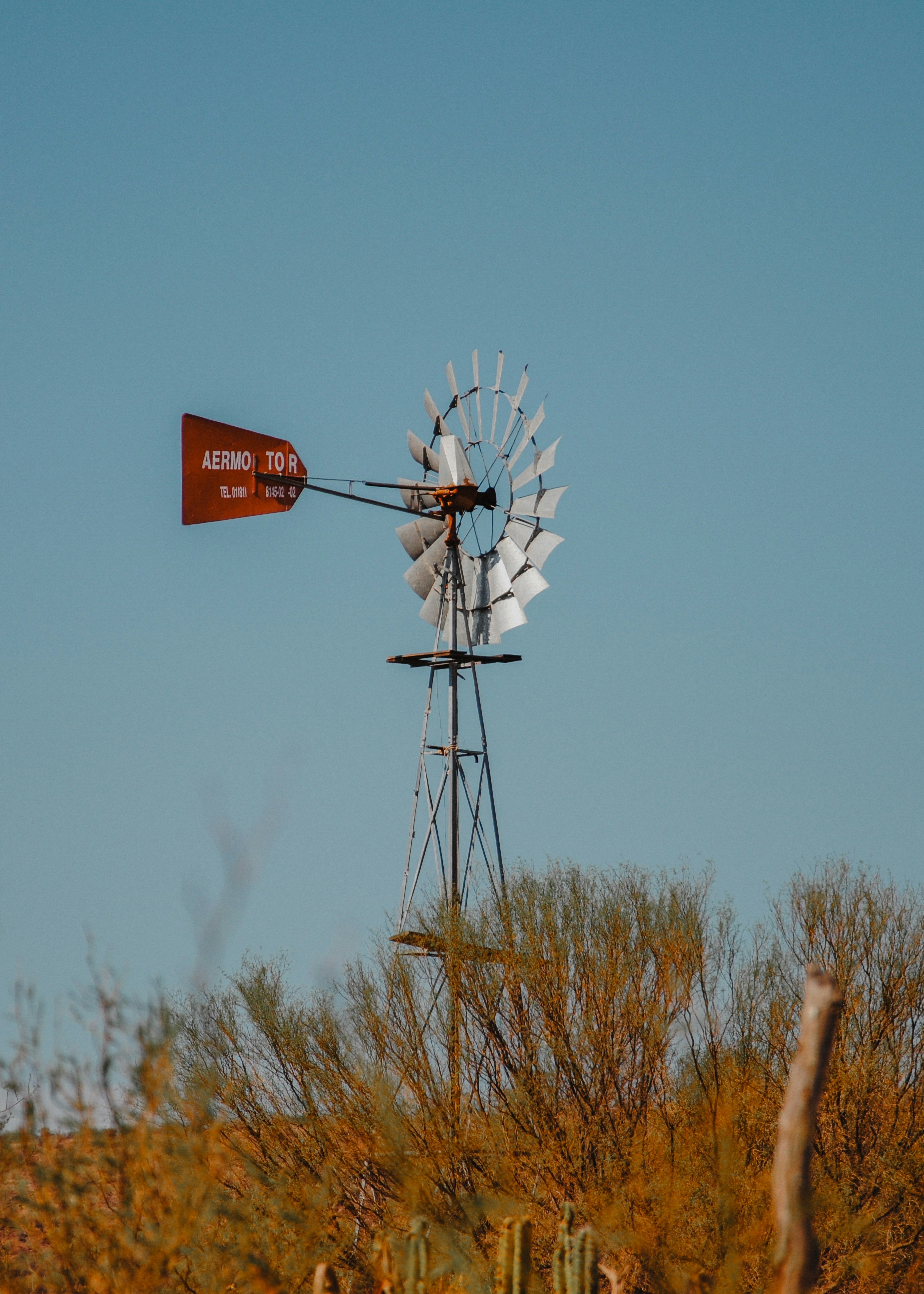 Desert Windmill: Sentinel Under a Crystal Blue Sky