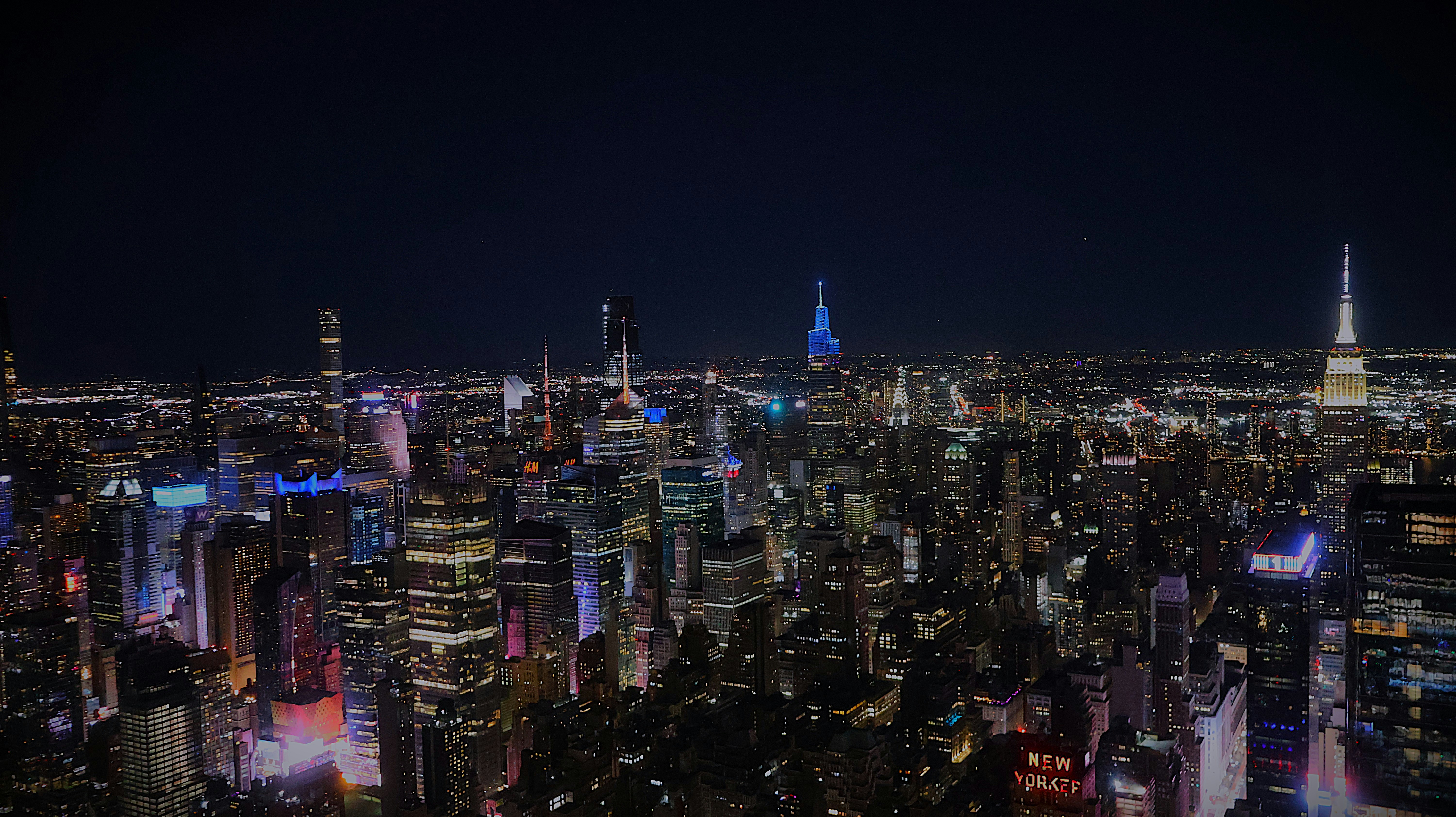 Vibrant city skyline with glowing skyscrapers against a dark night sky.