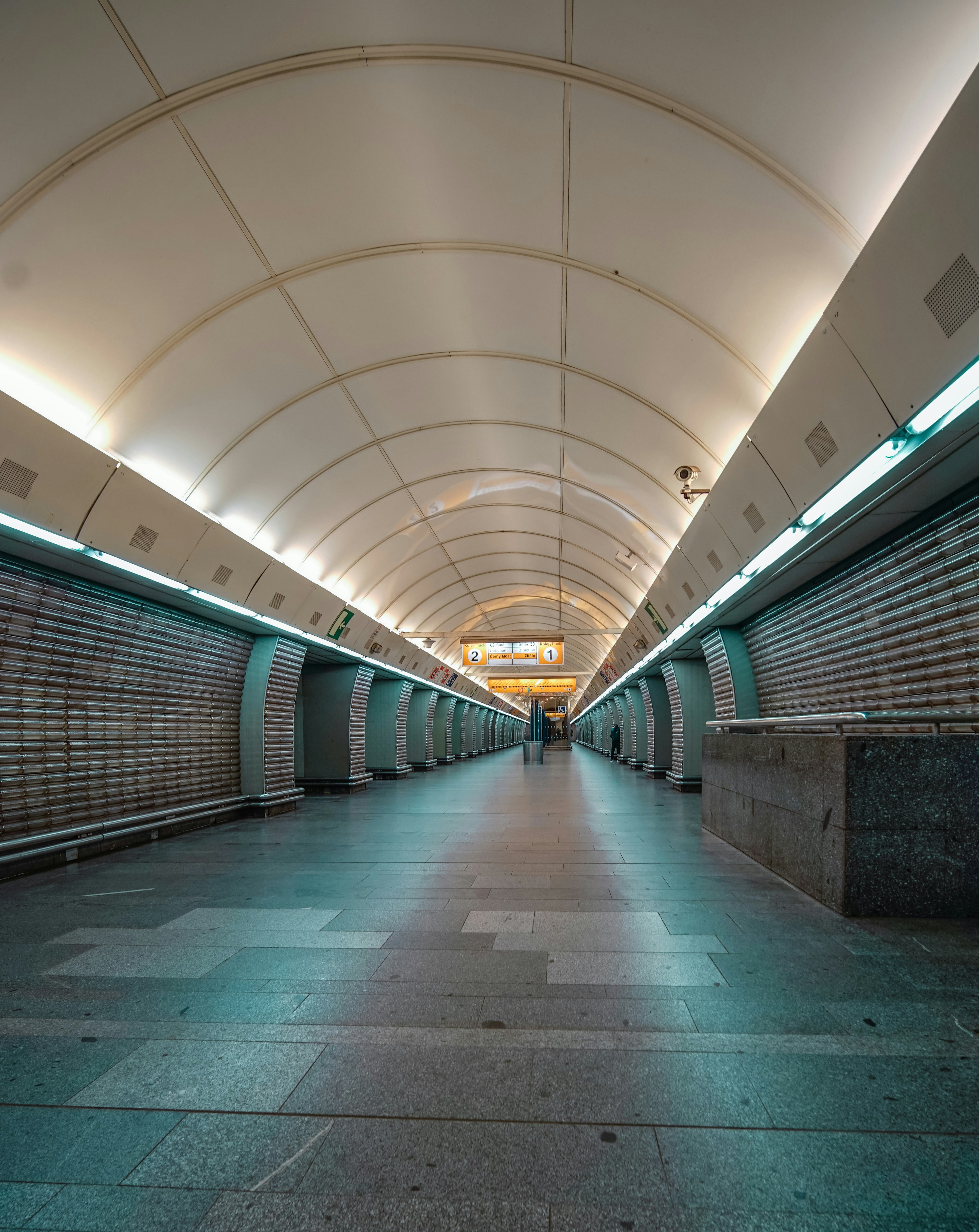 An empty subway station hallway stretches into the distance. photo ...