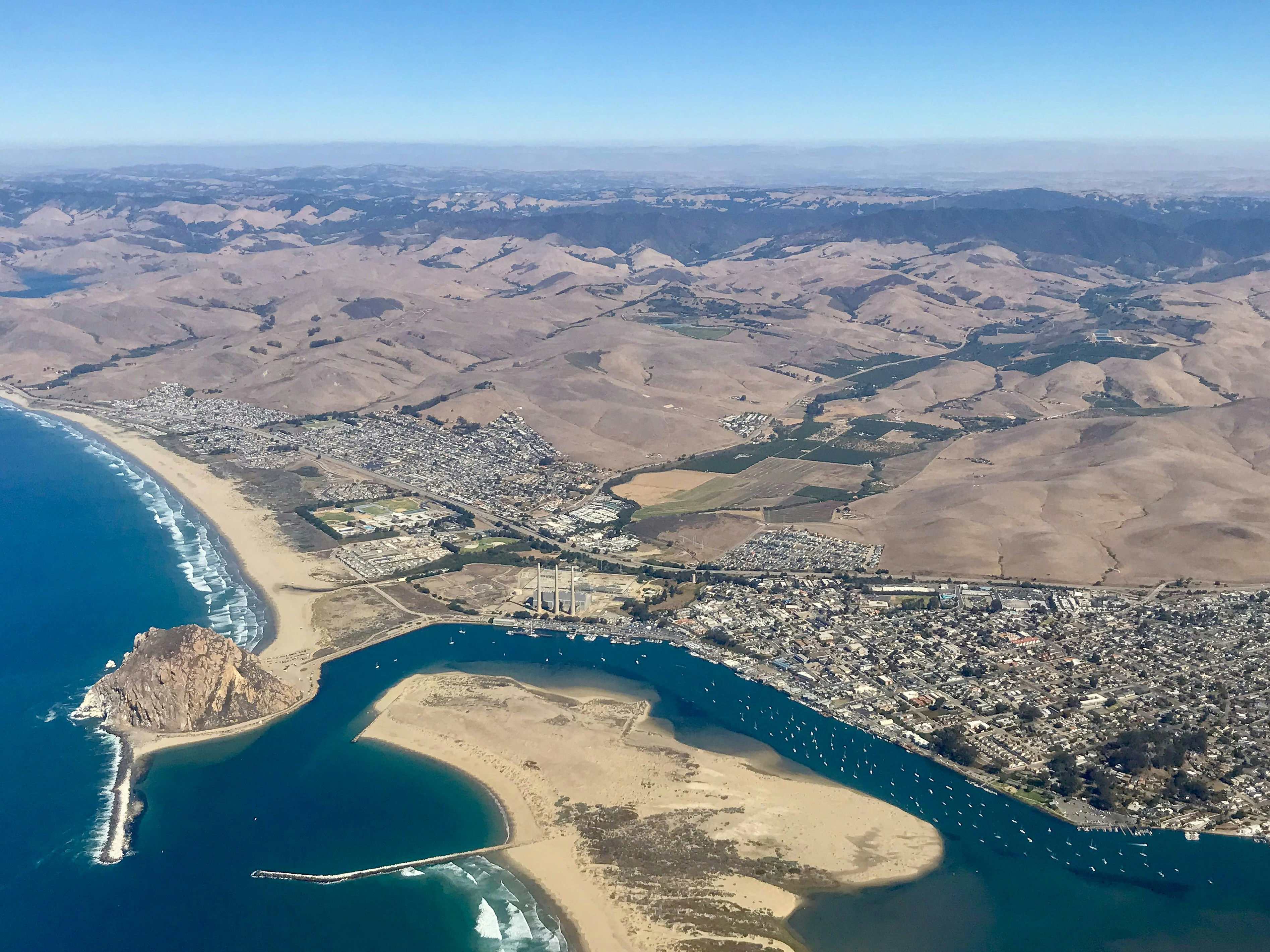 Crescent Harbor Over Turquoise Bay: An Aerial Portrait of a Desert Coastline