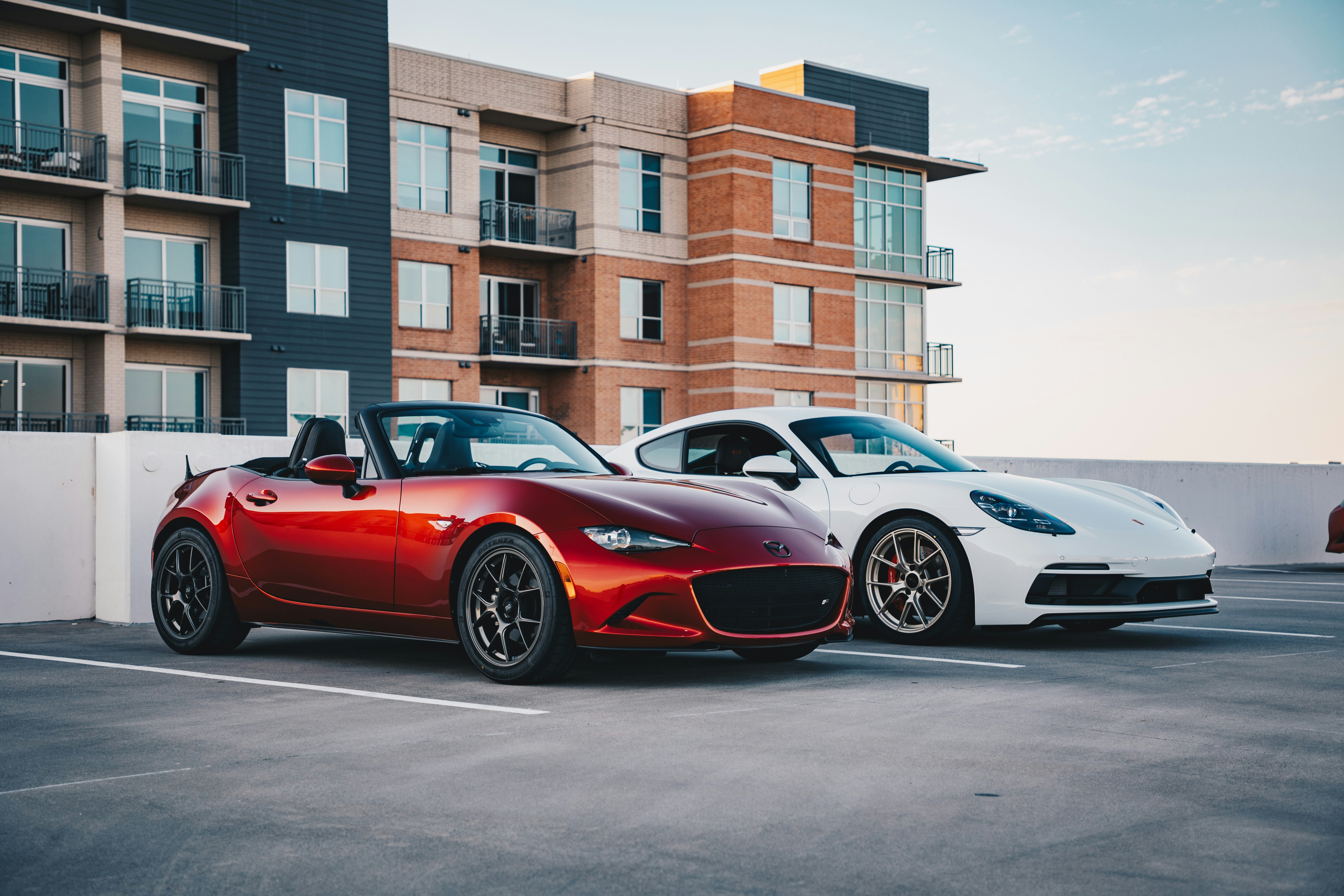 Two sports cars parked on a rooftop parking garage. photo – Free Car ...