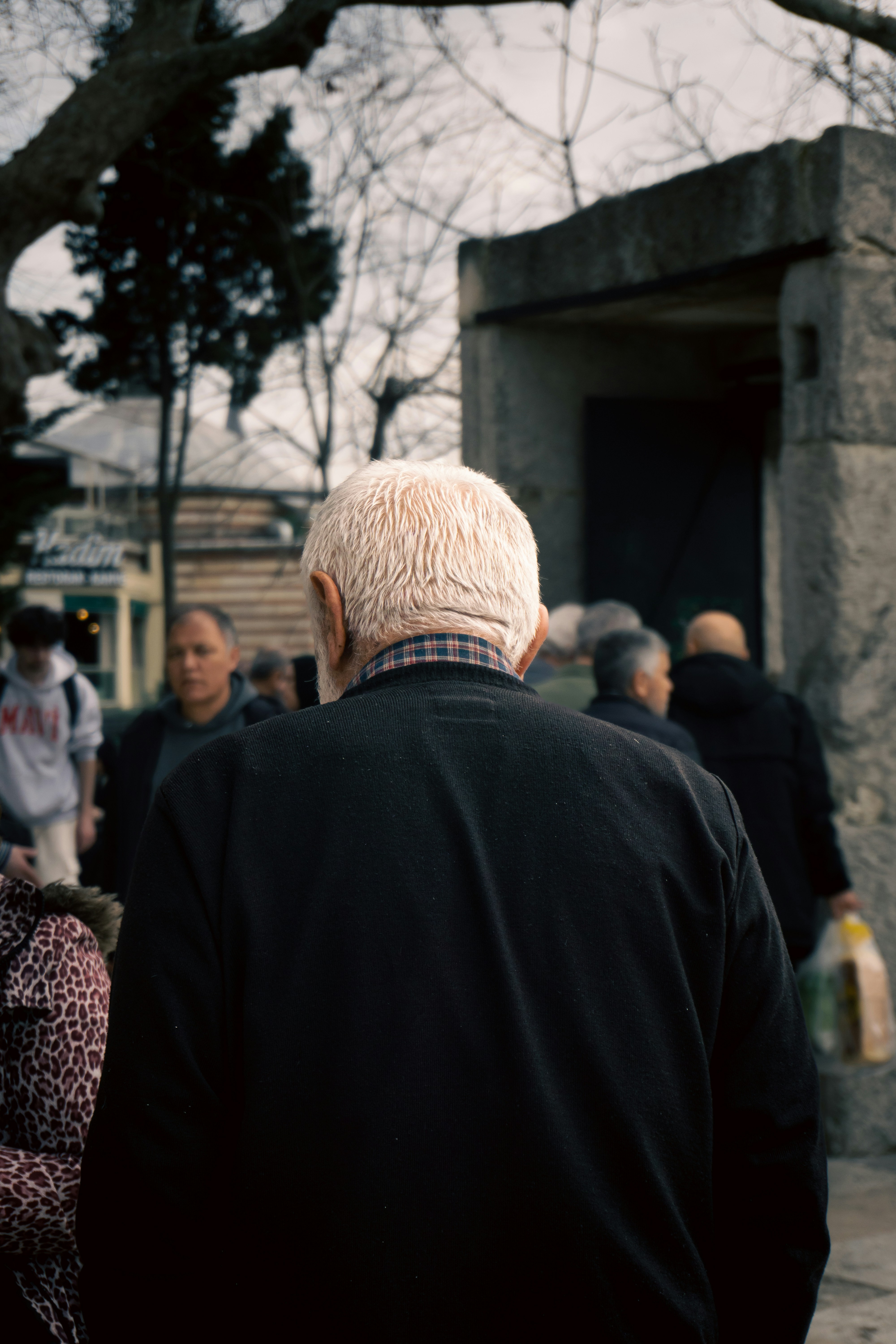 Back-View in the Market: Quiet Authority Amid the Crowd
