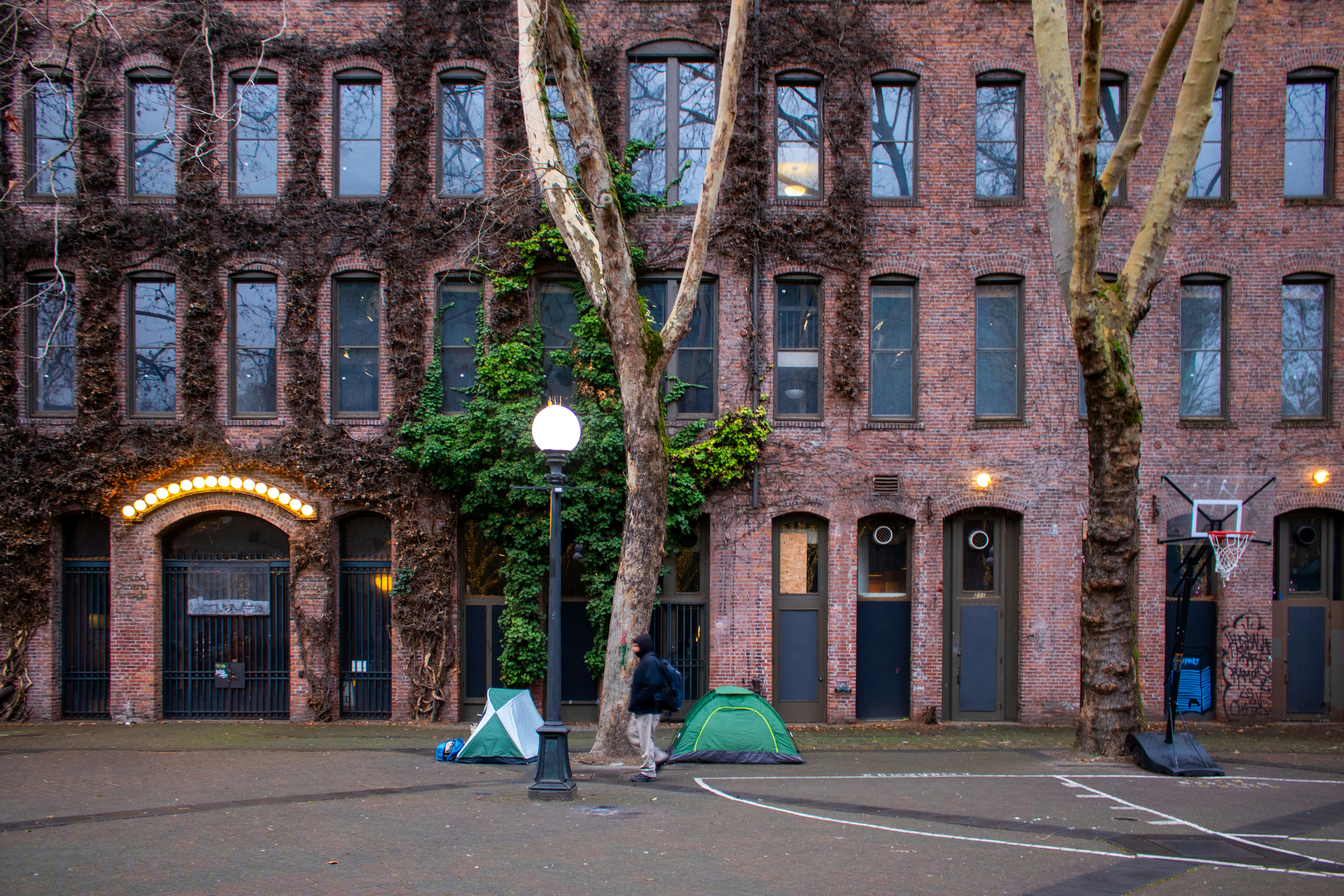 Homeless encampment in front of a brick building. photo – Free City ...