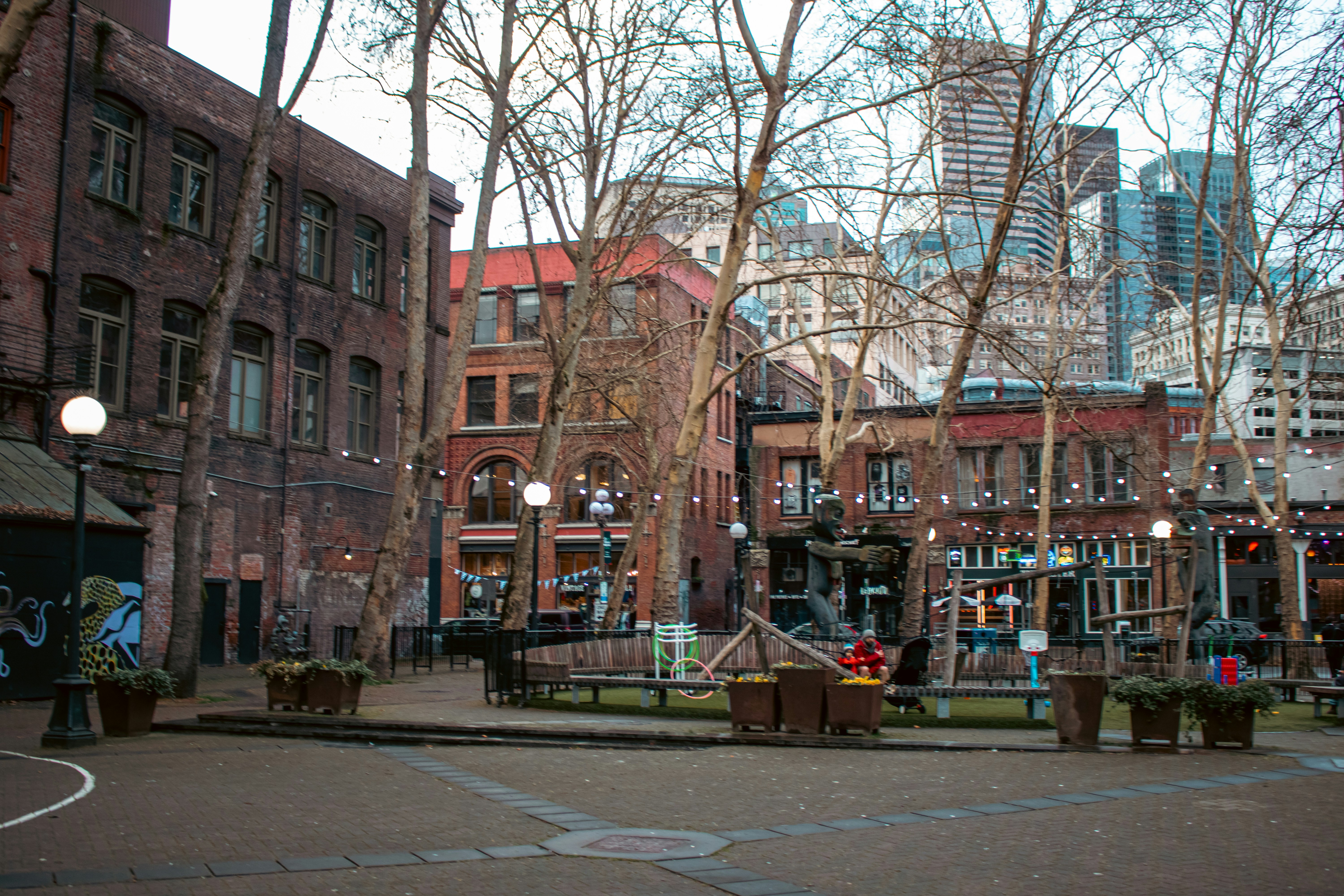 Urban square surrounded by buildings and bare trees. photo – Free City ...
