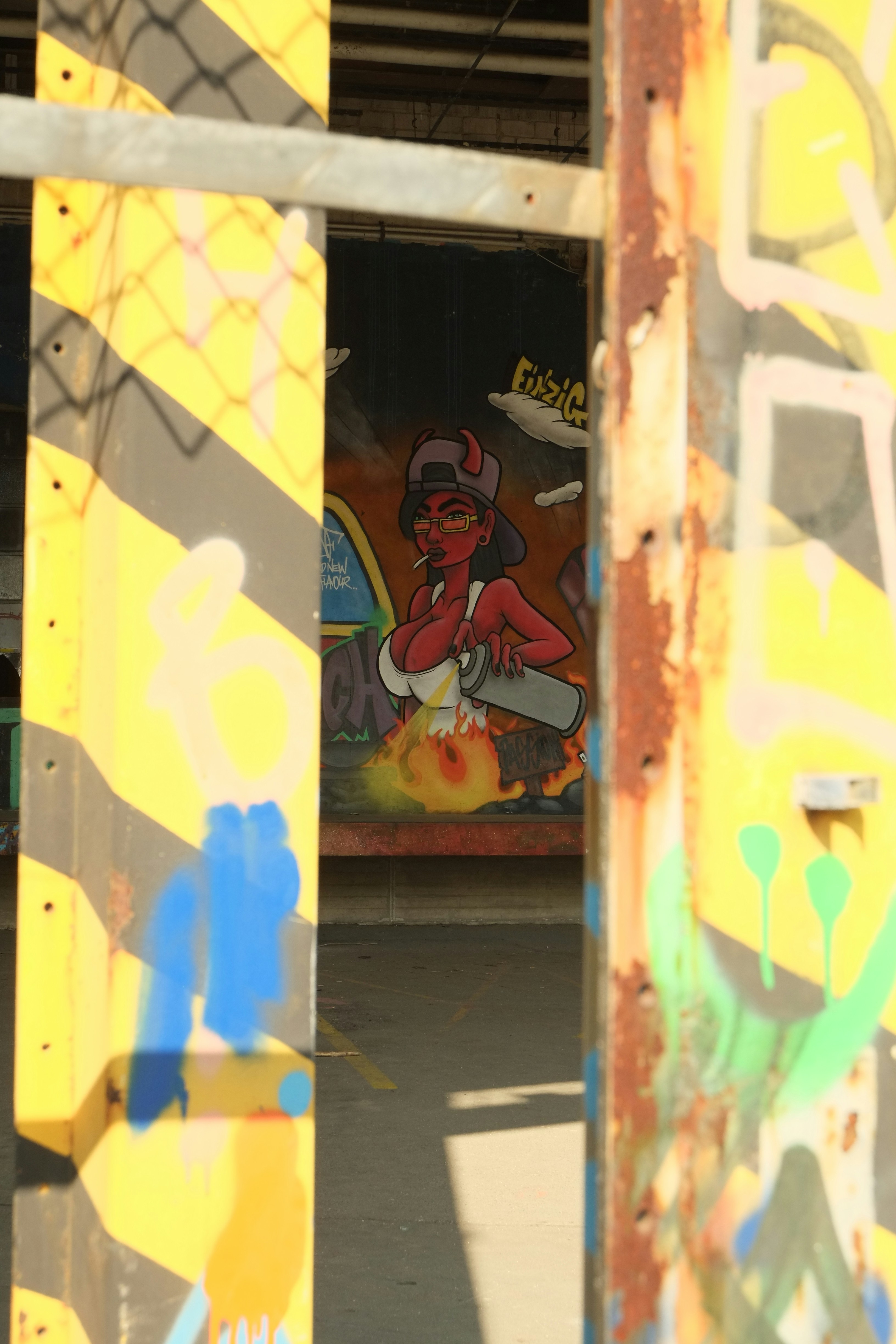 Graffiti art of a devil woman behind a yellow gate. photo – Free Art ...