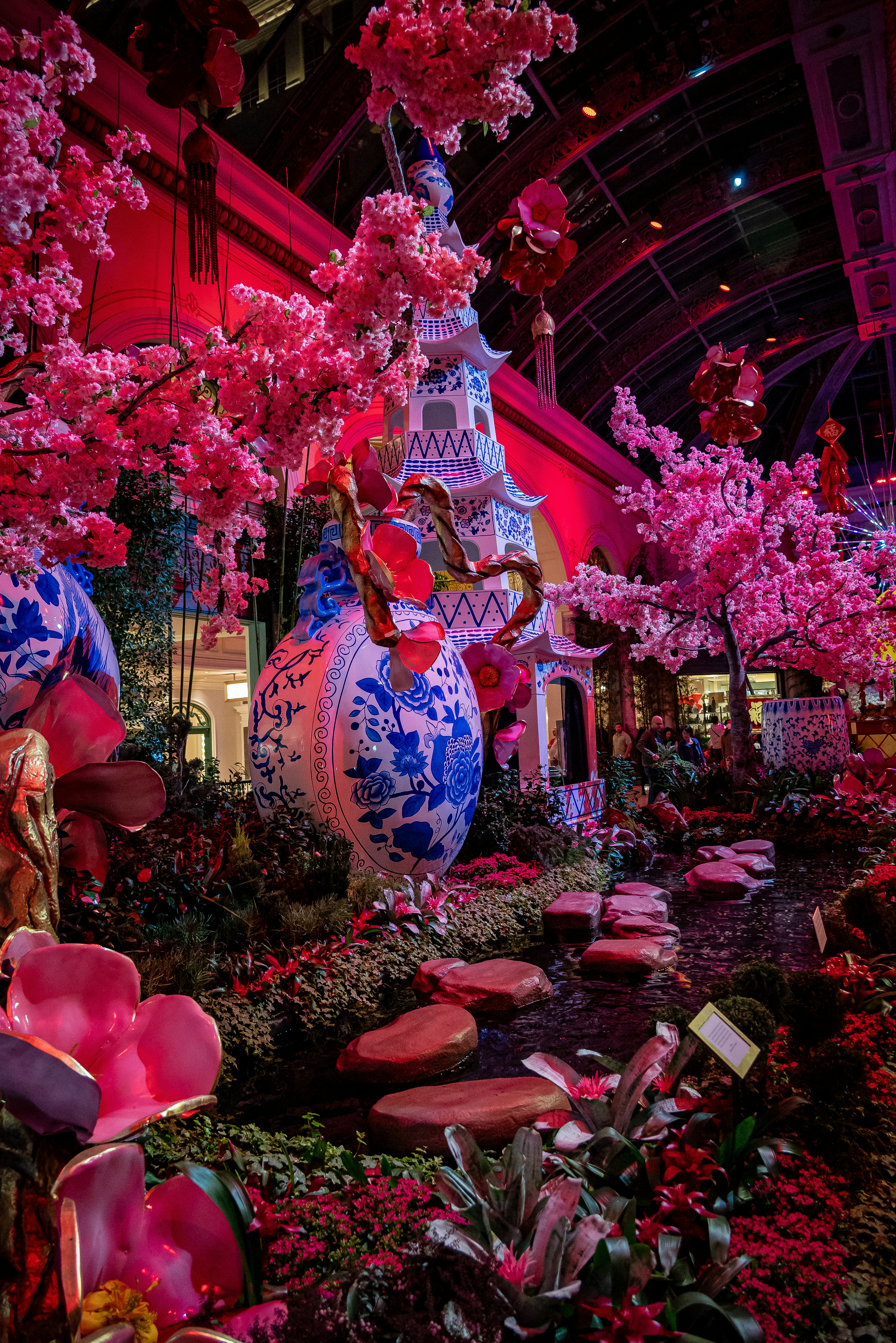 Crimson Bloom Corridor: A Ceremonial Garden Inside a Night-lit Pavilion