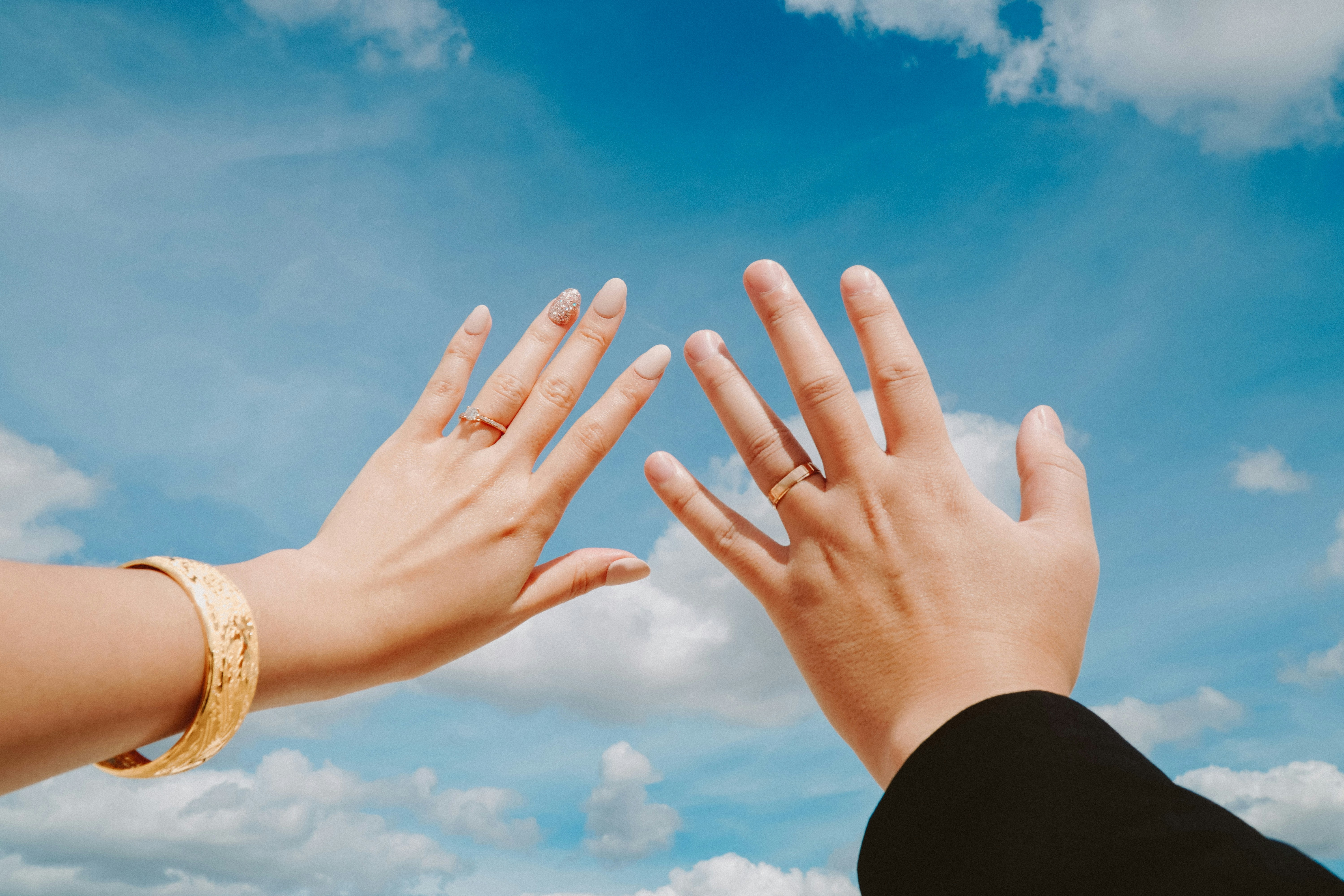 Wedding rings on display against the sky. photo – Free Blue Image on ...