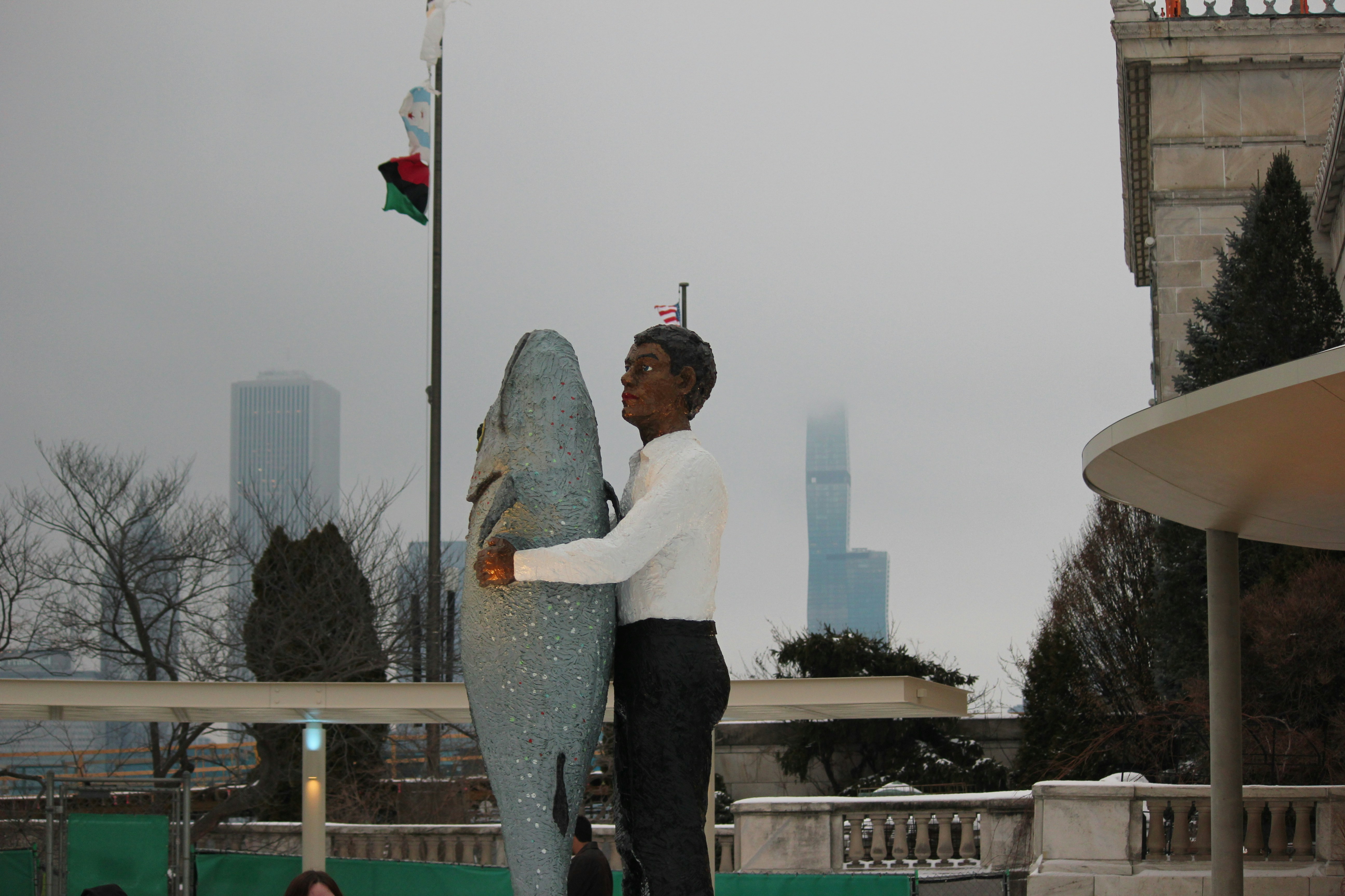 Surfacing Silence: A Surfboarder Statue Guarding a Waterfront Vista