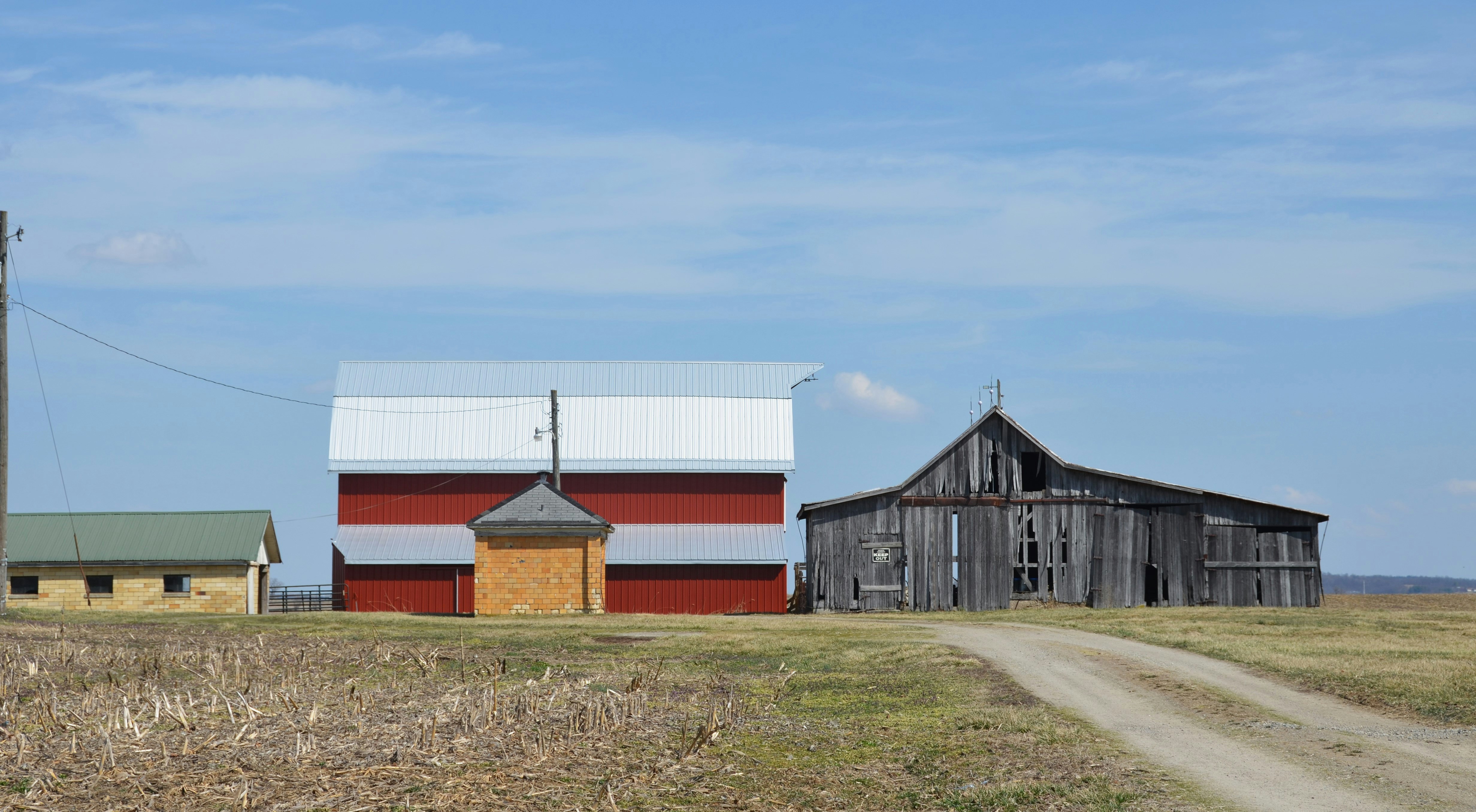 Three barns sit on a rural, grassy property. photo – Free Farm Image on ...