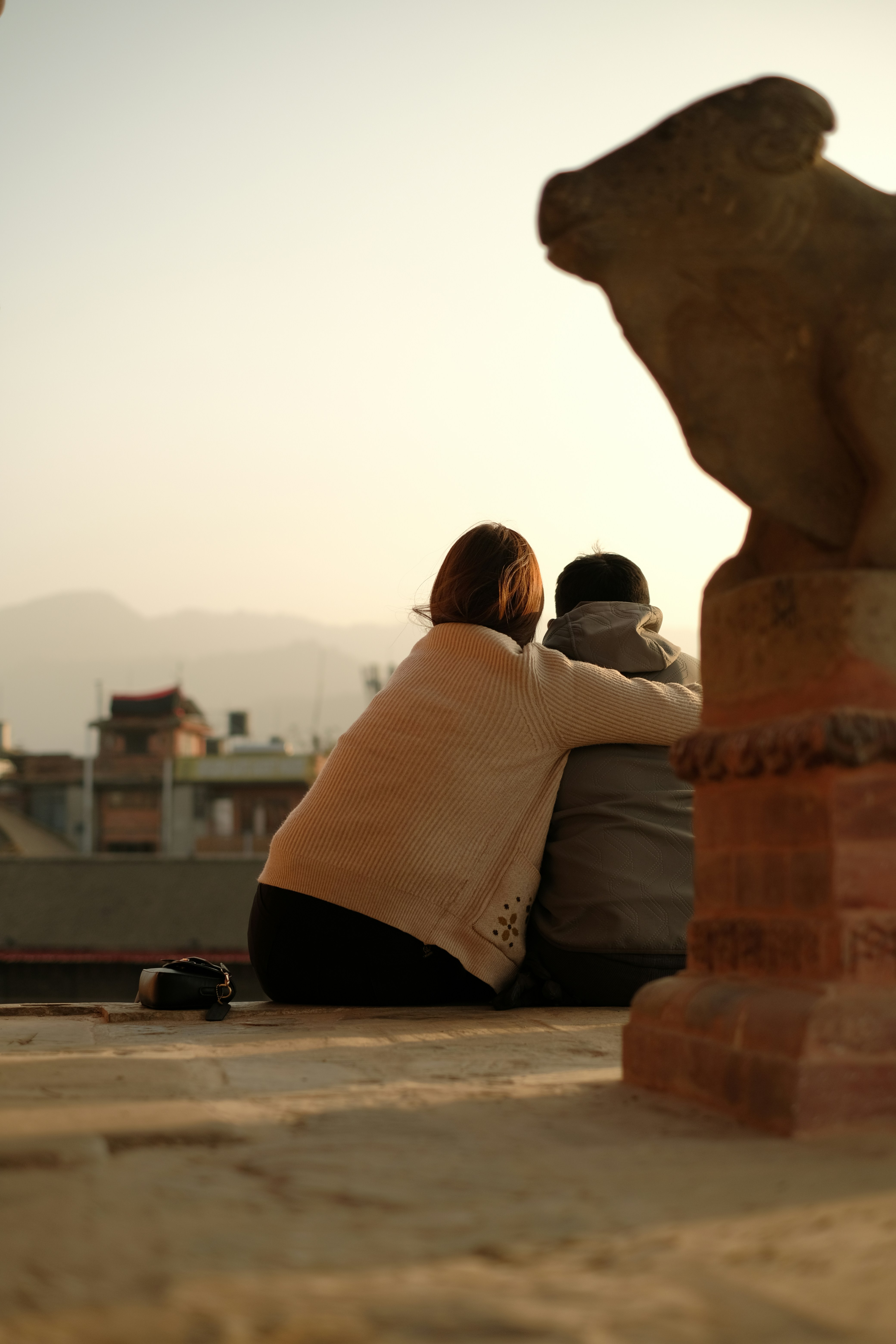 Rooftop Sunset: A Quiet Embrace Beneath a Distant City Glow