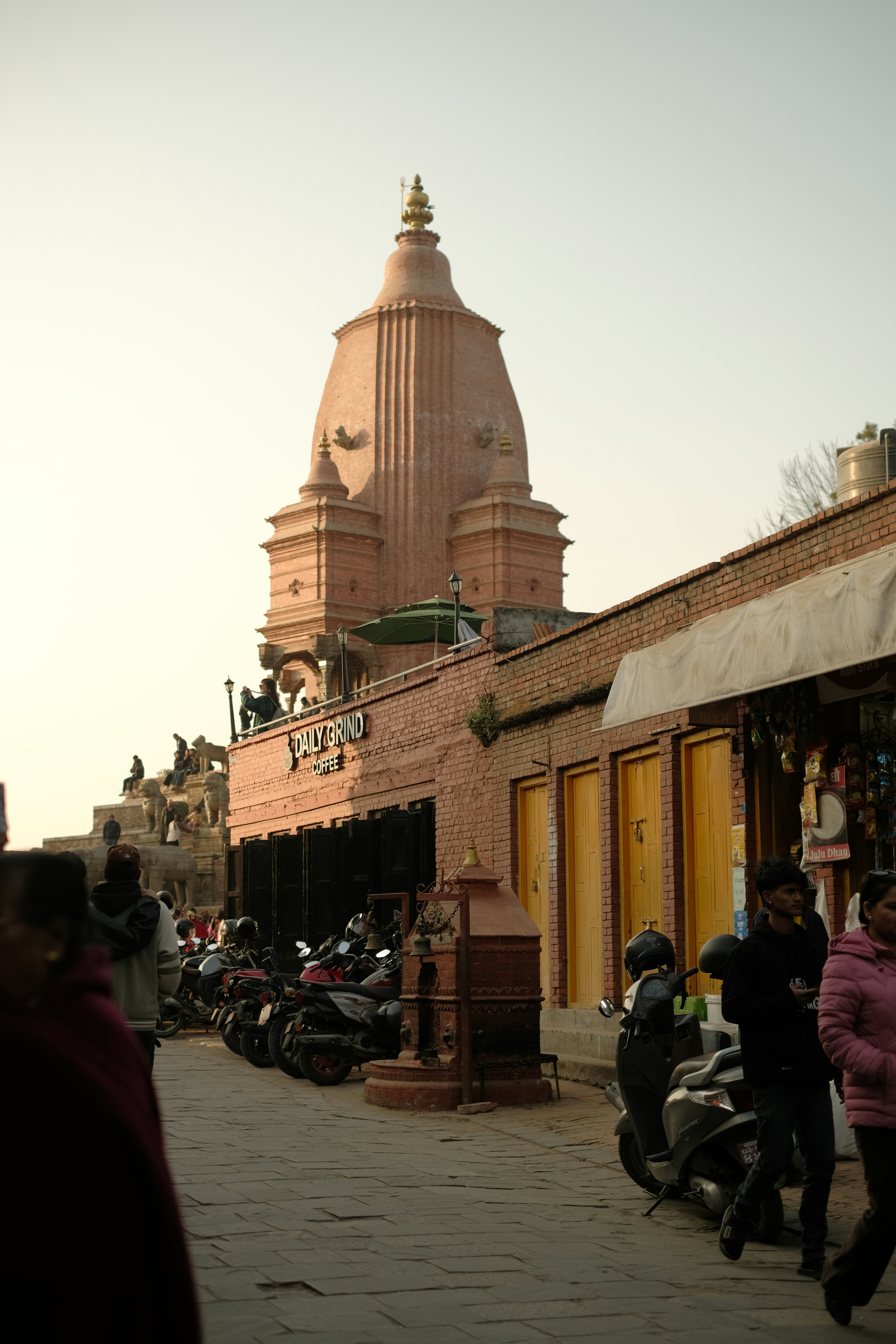 Sunlit Temple Spire Over a Lively Street Market