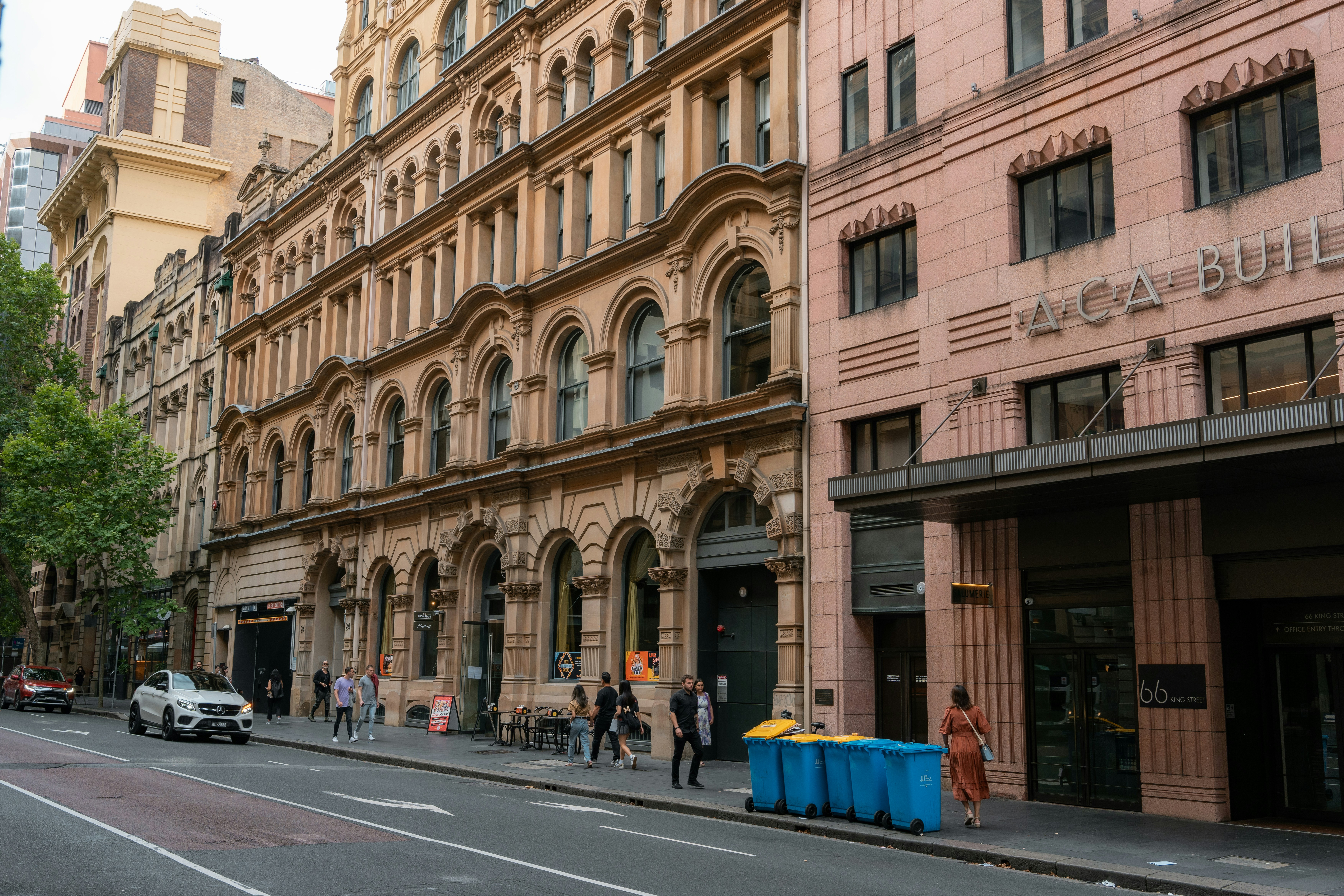 Historic buildings line a city street with pedestrians. photo – Free ...
