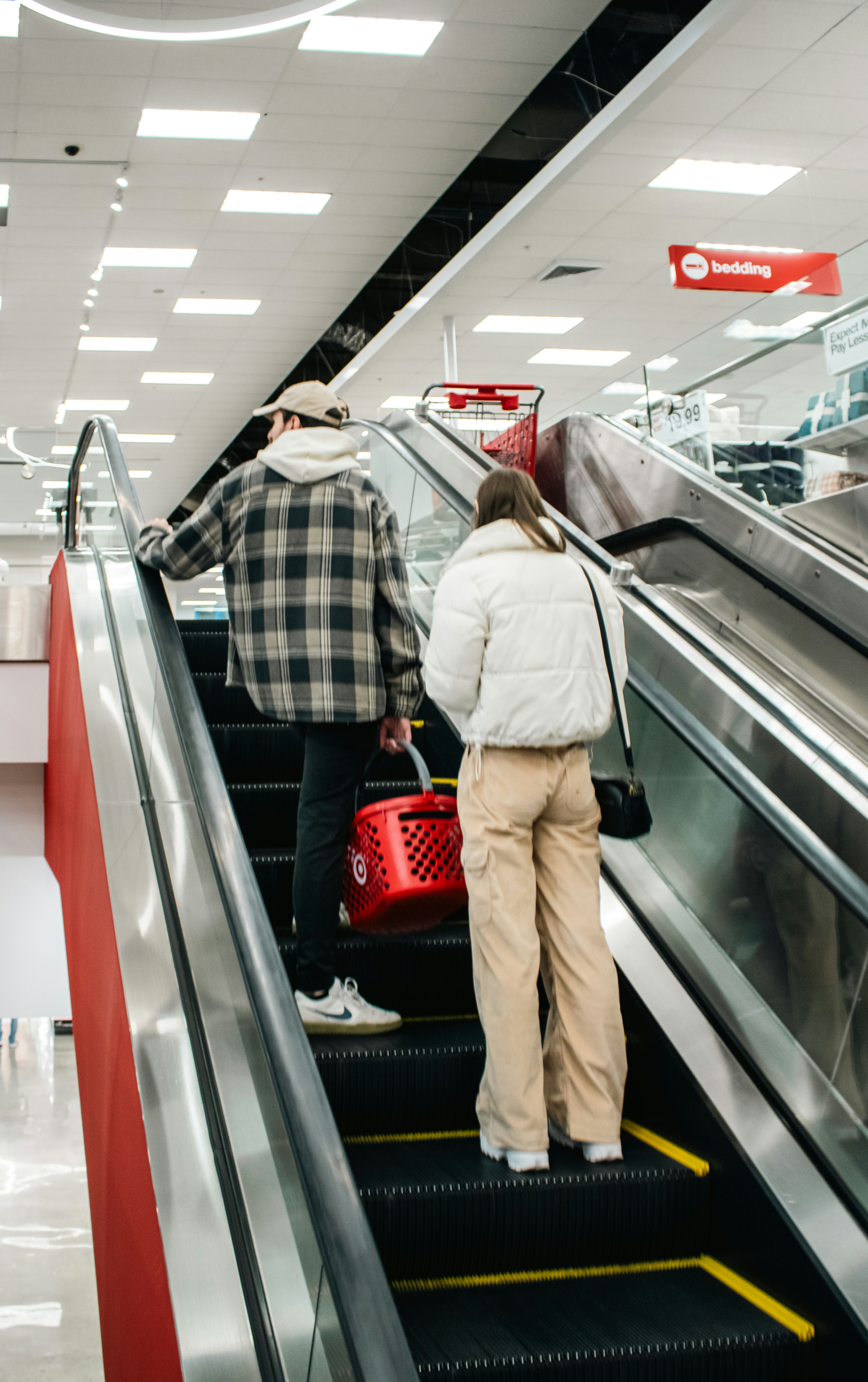 People ride up an escalator at target. photo – Free People Image on ...