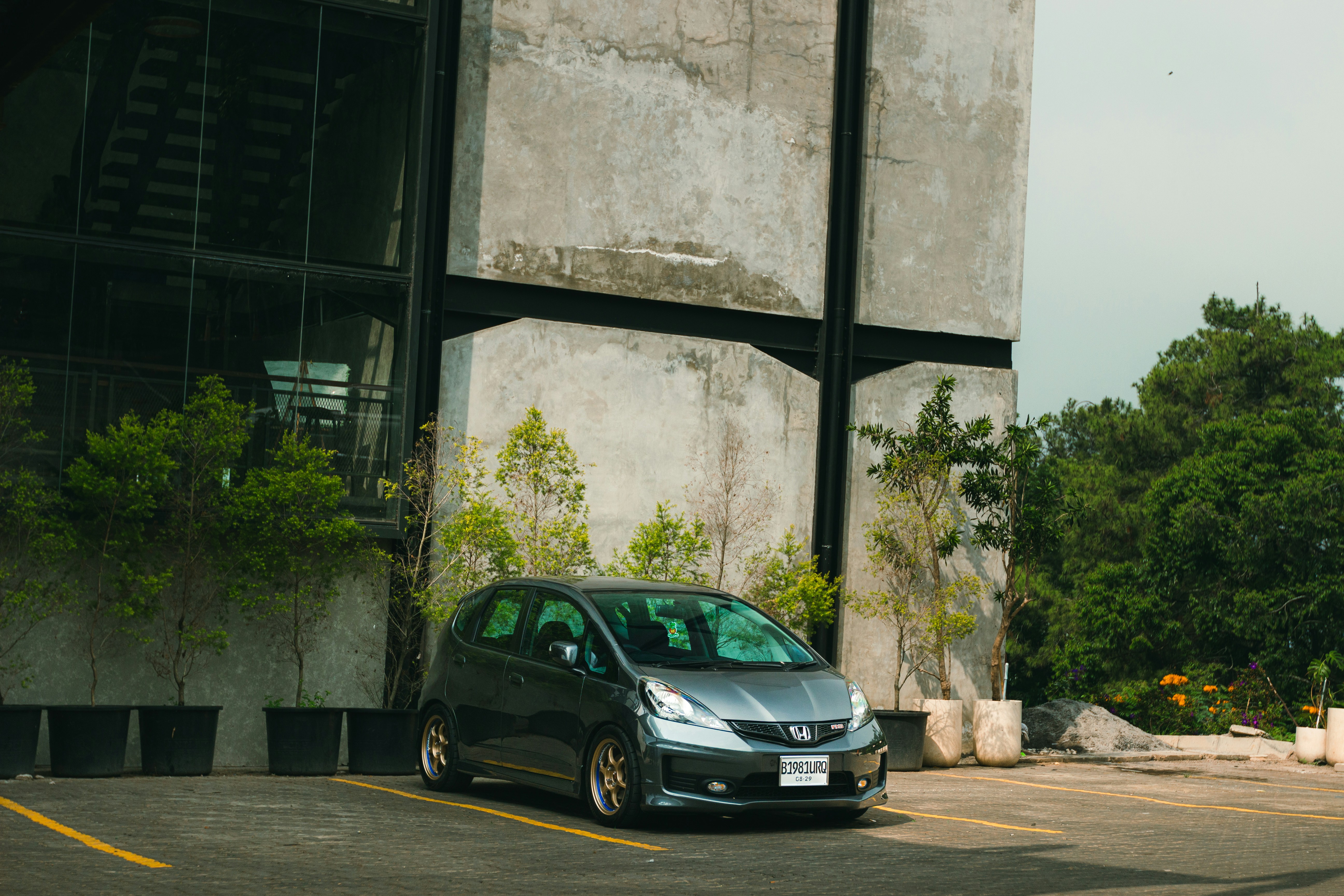 Urban Serenity: Compact Car in an Industrial Haven