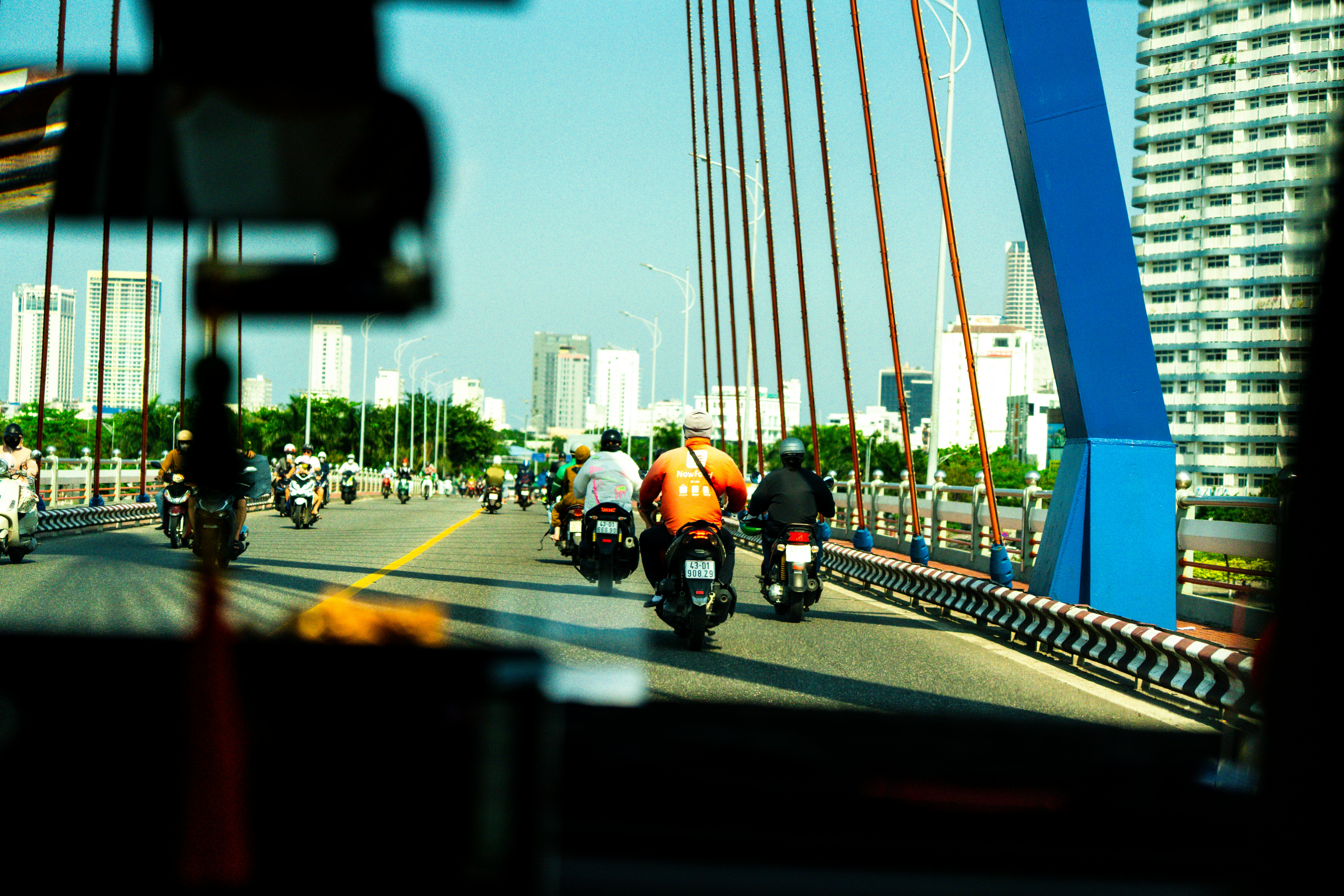 Bridge of Moving Shadows: Morning Riders Crossing a Sunlit Span