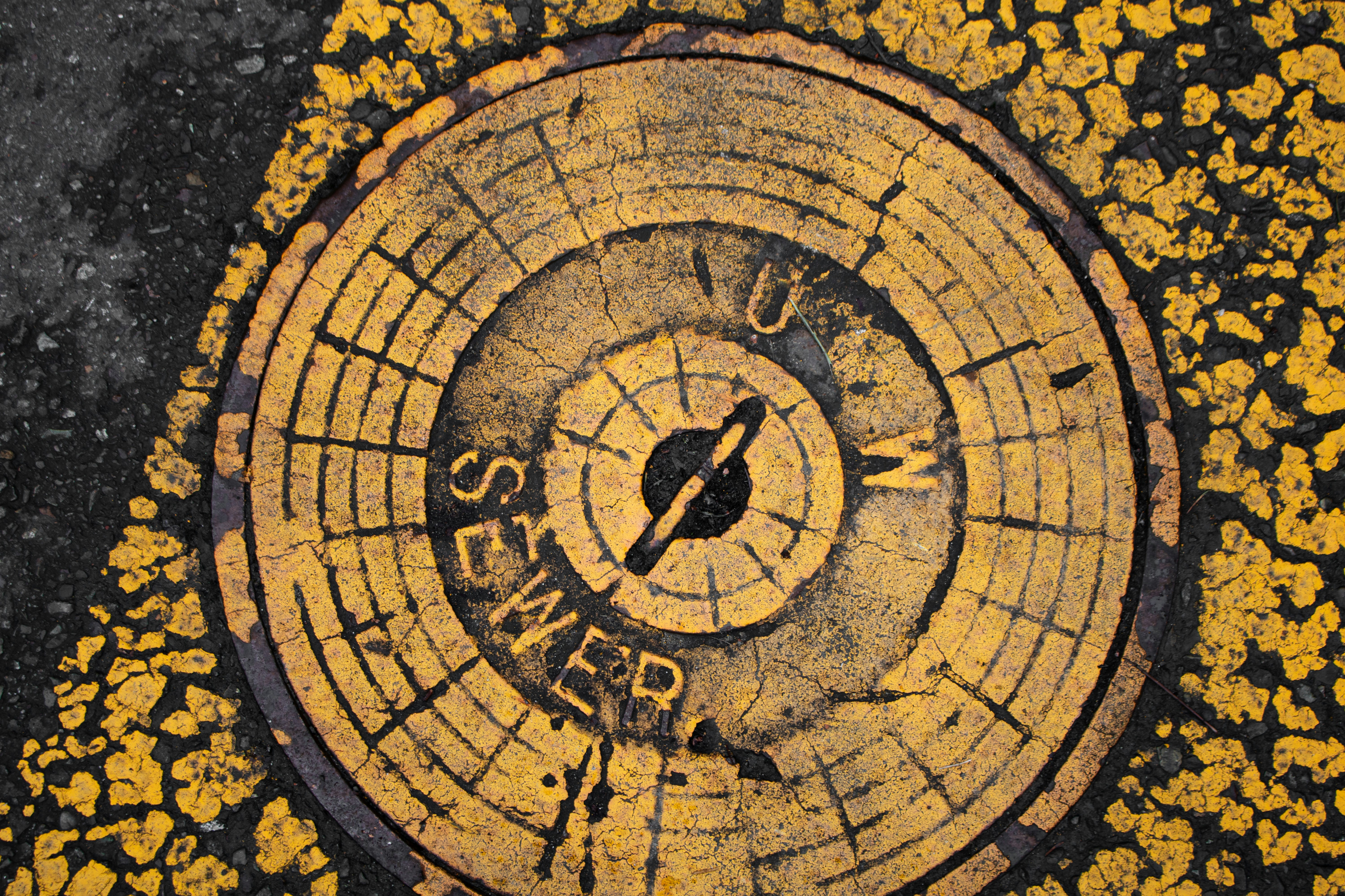 A round sewer cover marked with yellow paint. photo – Free Texture ...