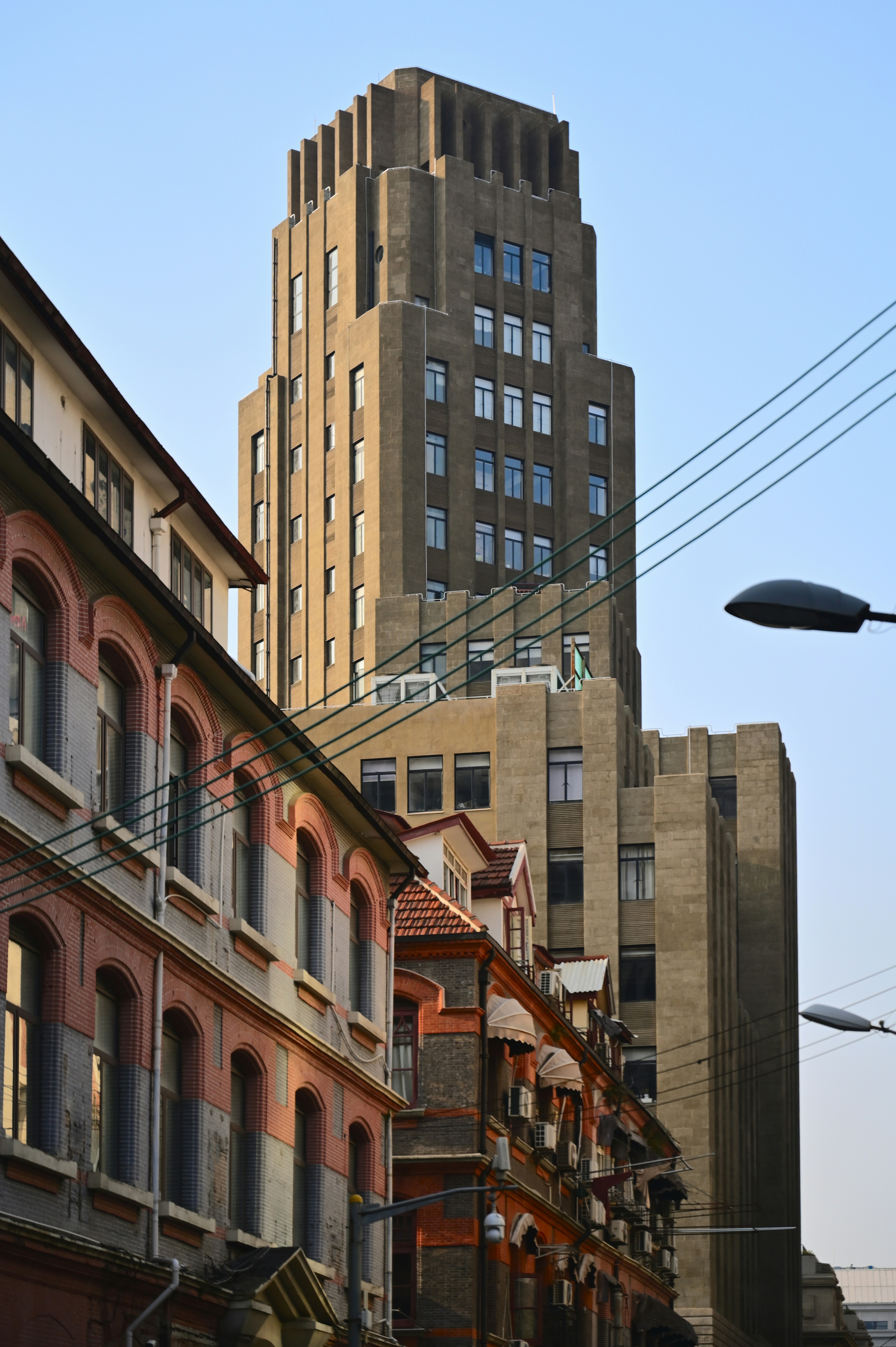 Urban Staircase to Sky: A Retro Tower Against Red Facades