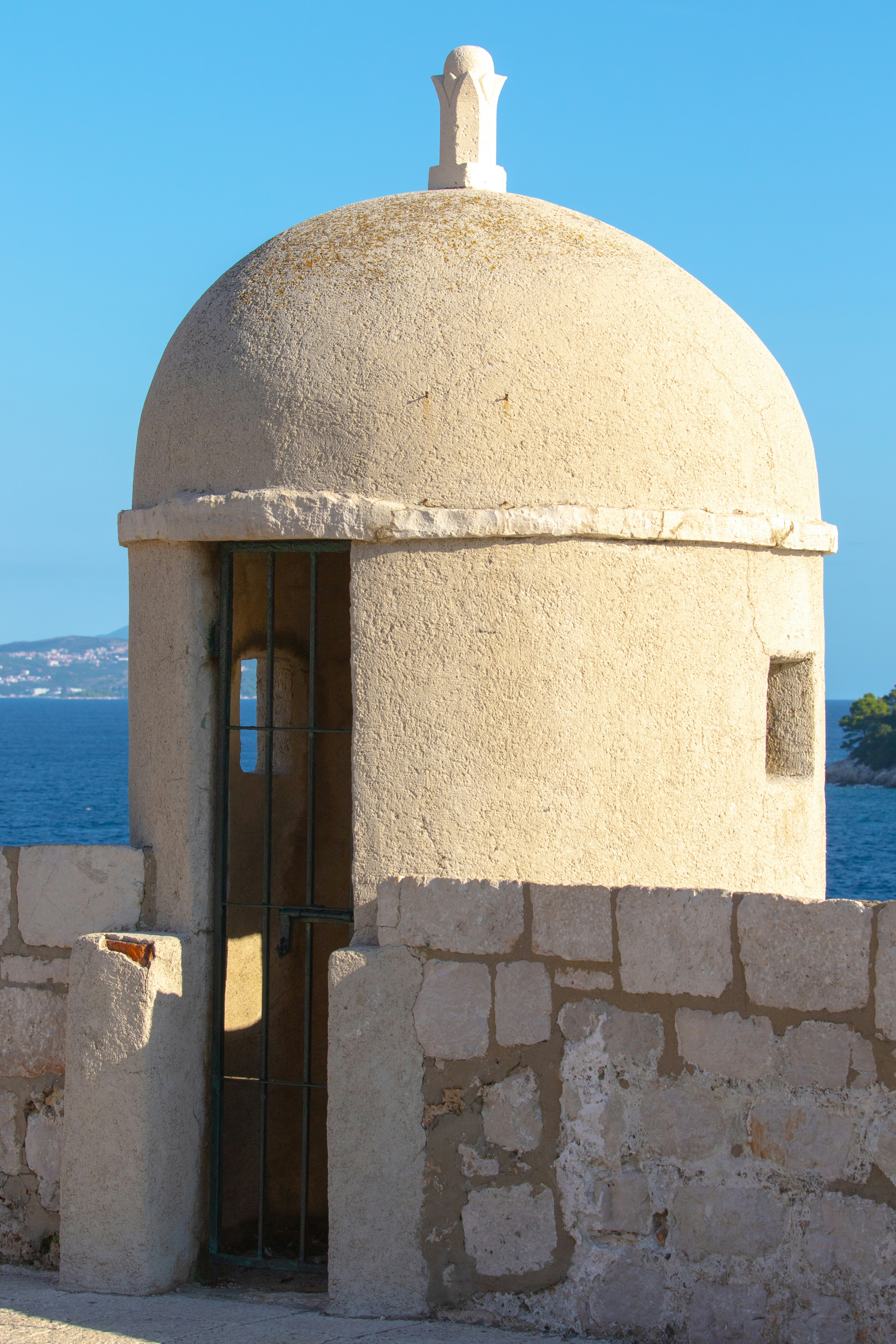 Coastal Dome Sentinel Over a Weathered Sea Wall