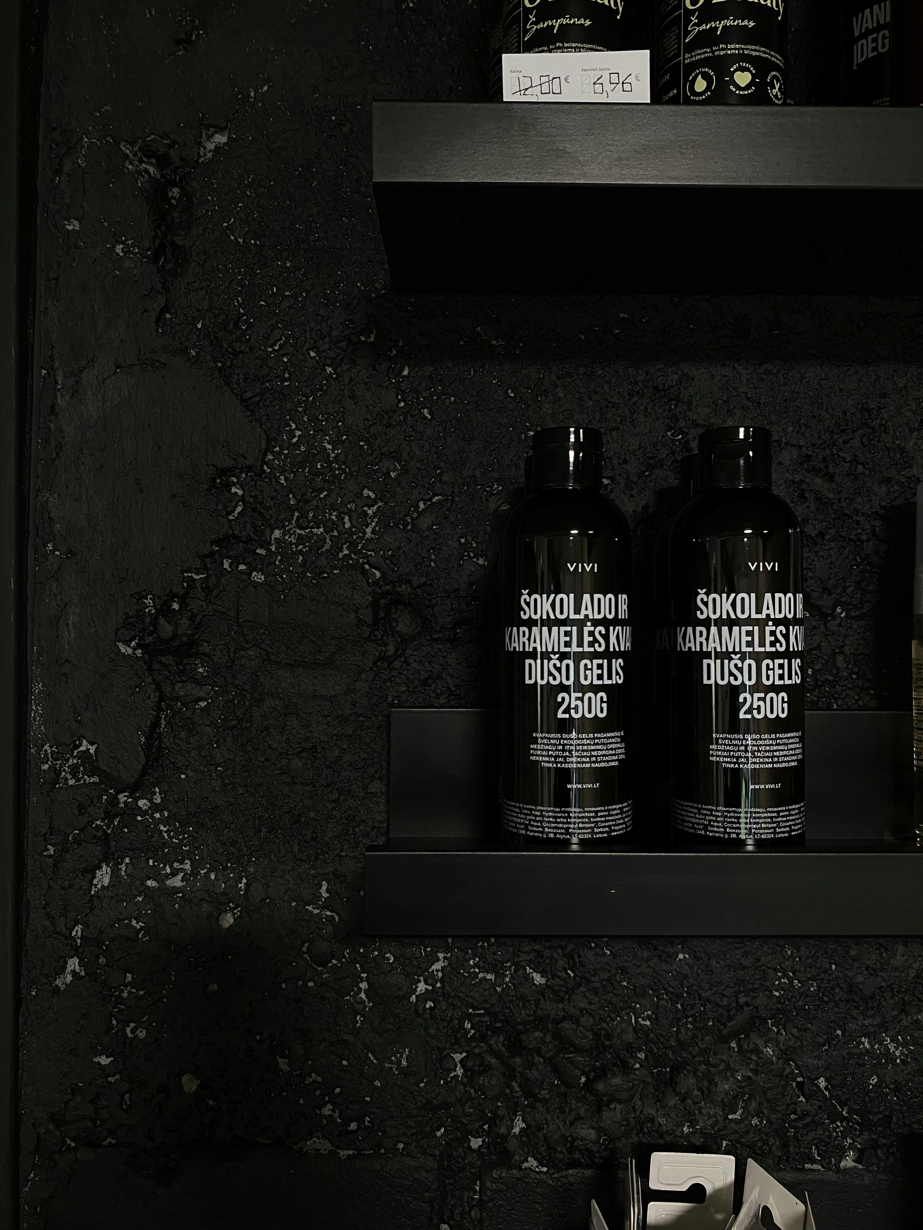 Two Noir Bottles on a Velvet-Textured Shelf