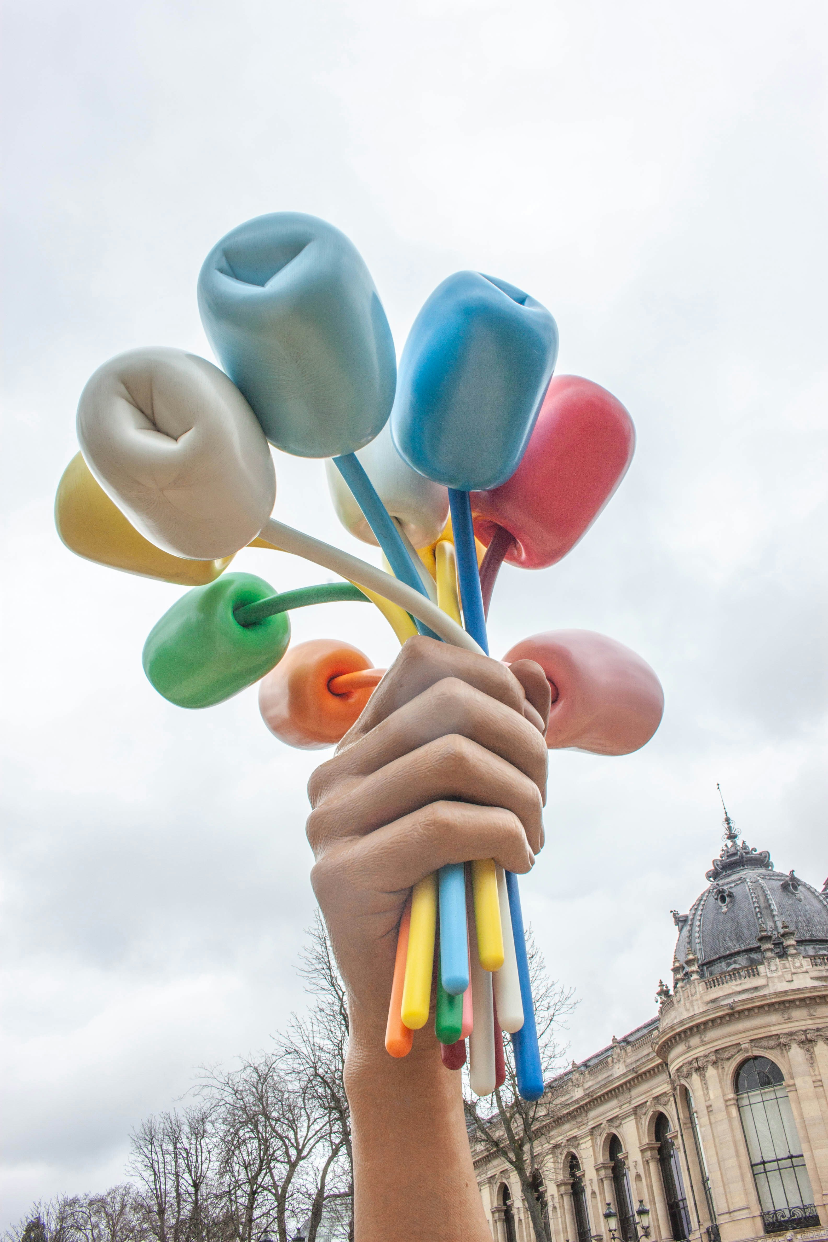 Colorful Balloon Bouquet Elevates Against a Historic Skyline