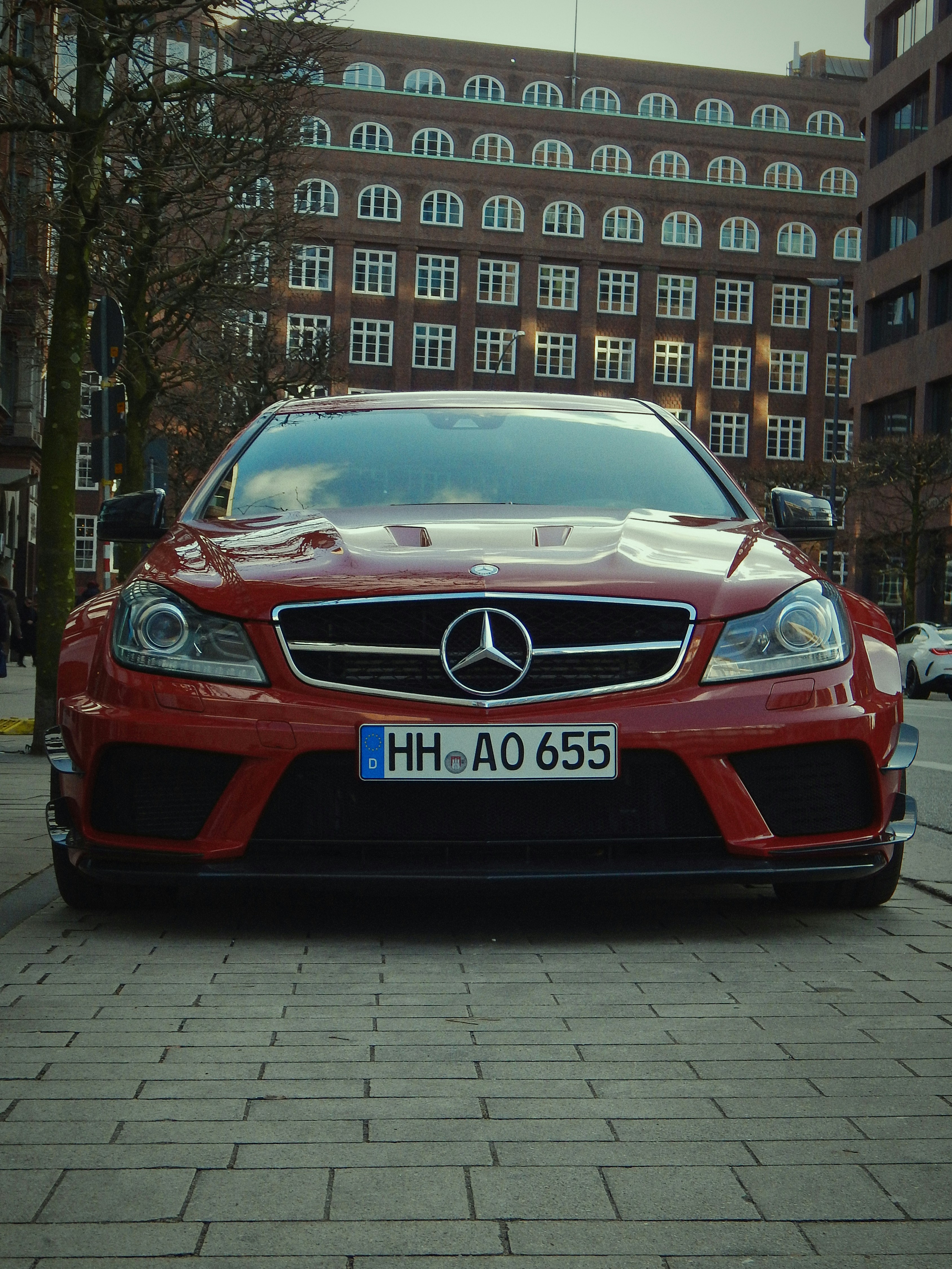 Front-and-Center: Red Mercedes Grille Portrait on a City Street