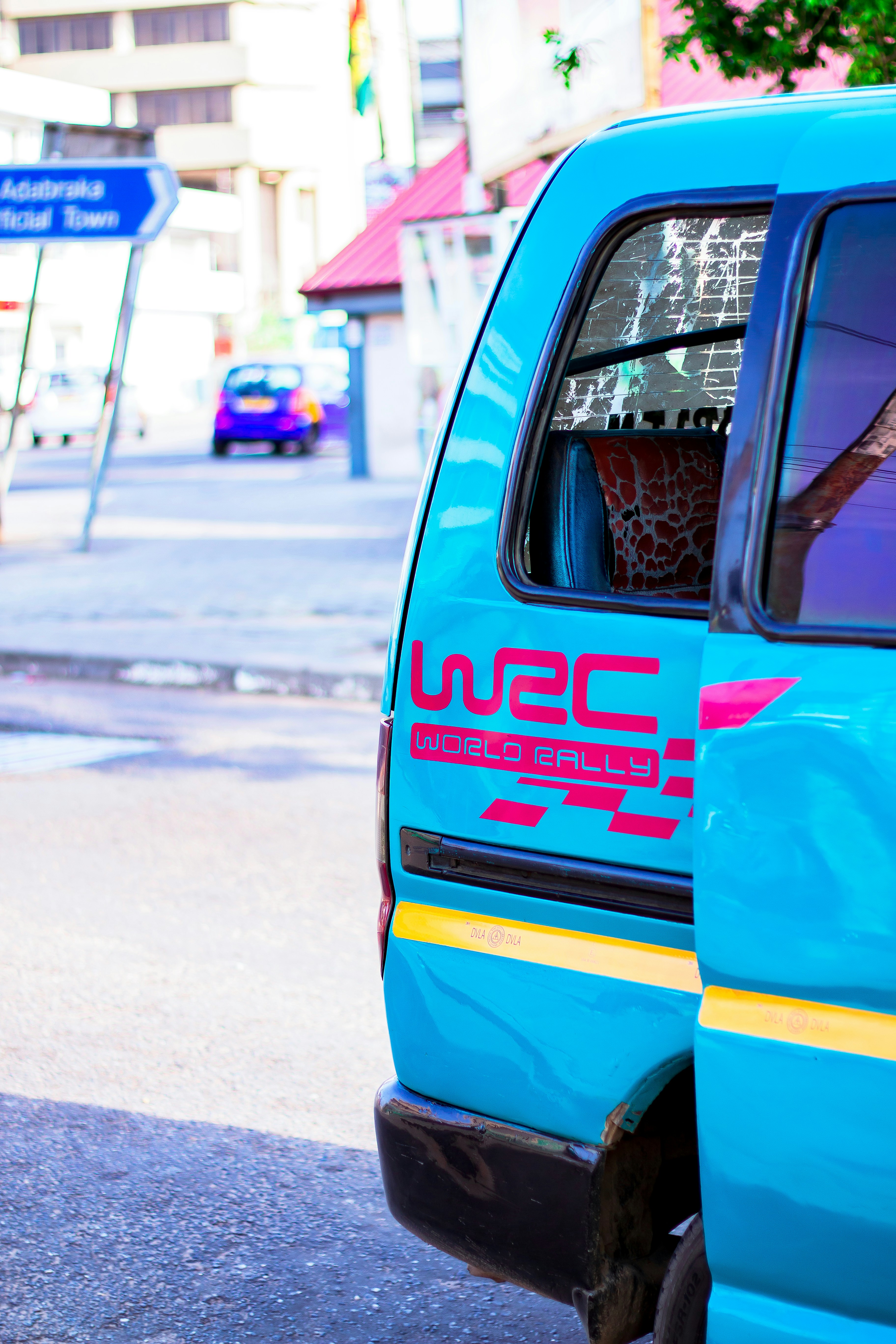 A blue minibus with "world rally" is visible. photo – Free Car Image on ...