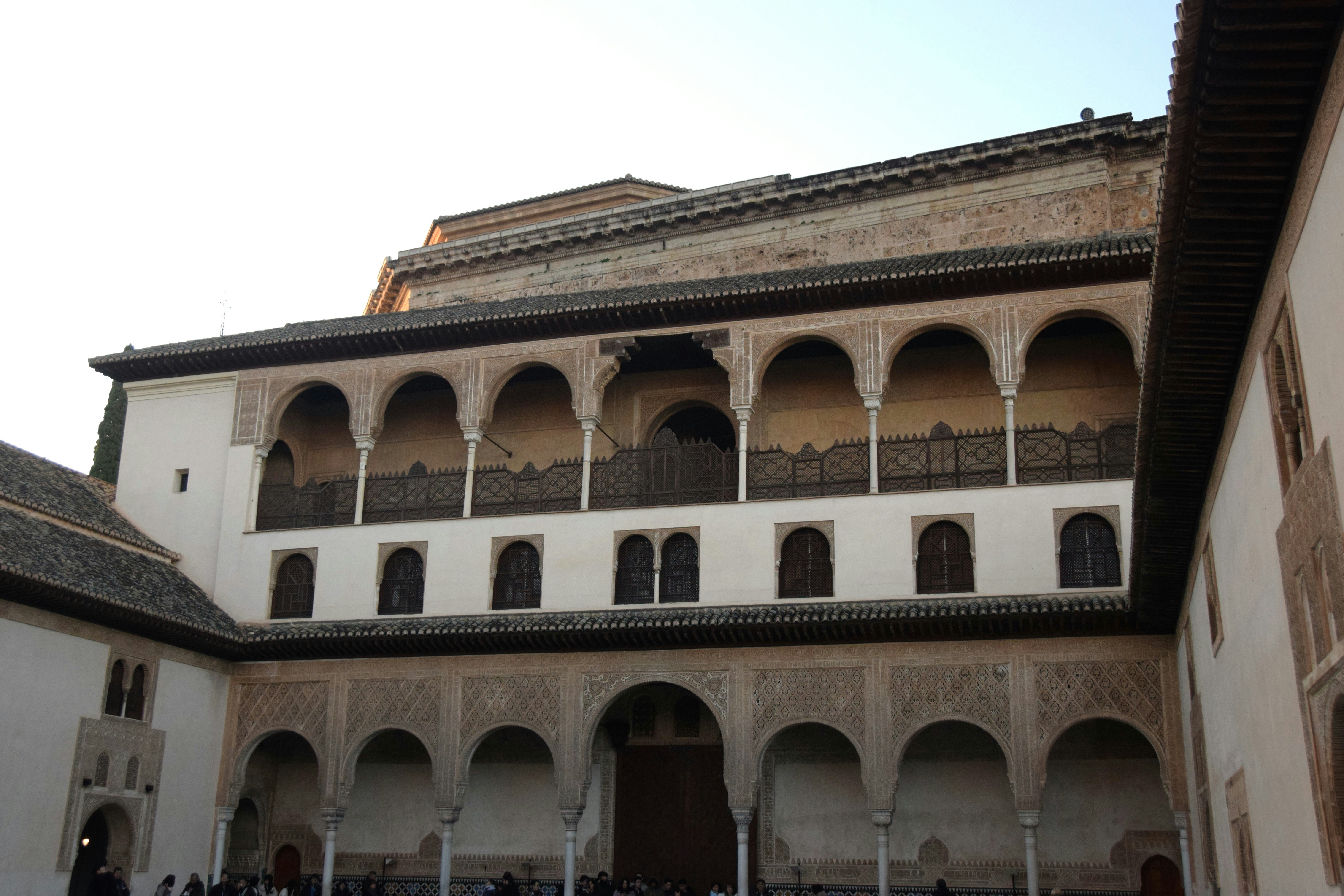Two-story structure with ornate Moorish arches and detailed stonework.